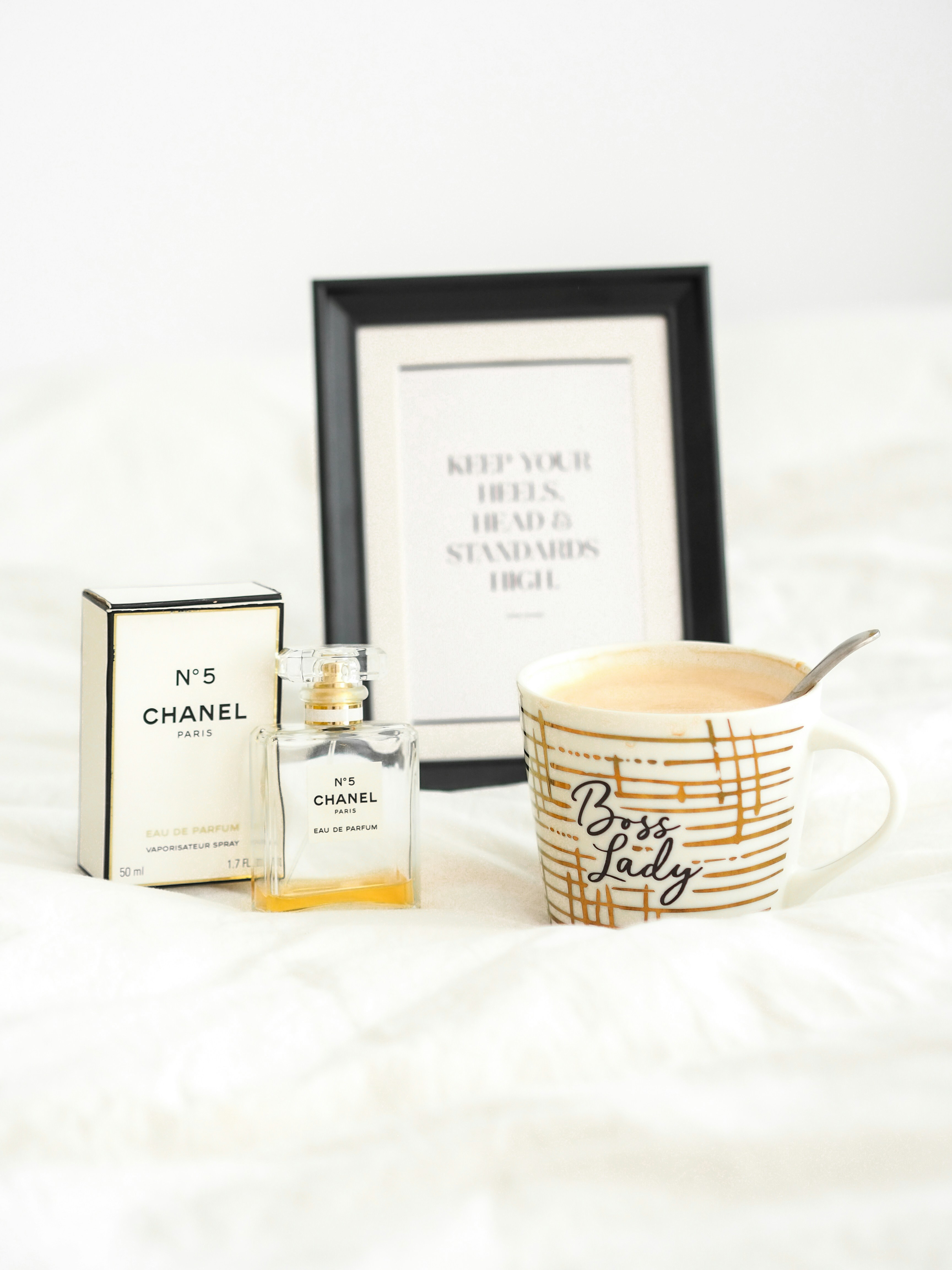 Chanel N°5, Framed Whisper, and a Boss Lady Mug on White Linen