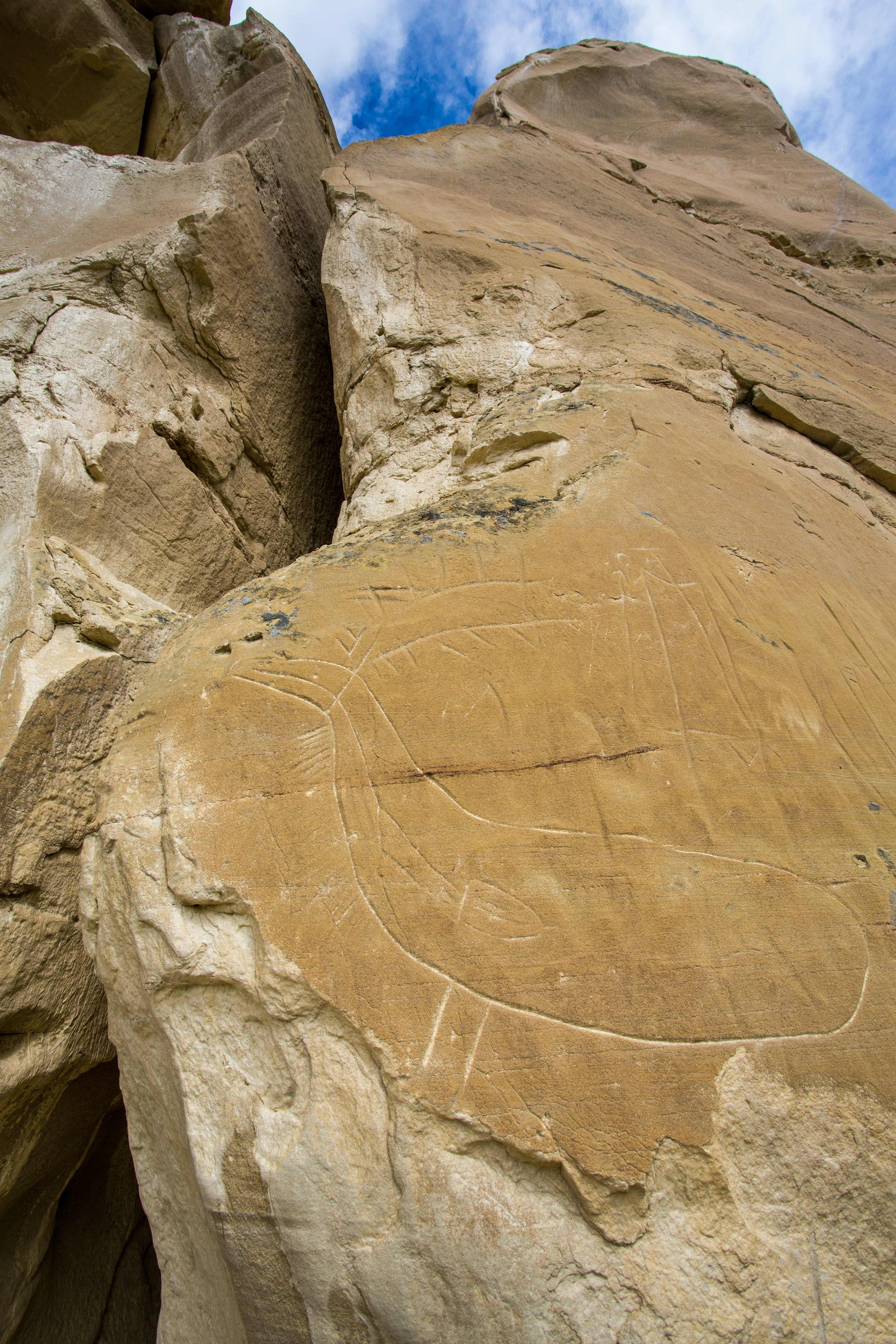 Circular Echoes on Desert Stone: Petroglyphs in Sunlit Sandstone