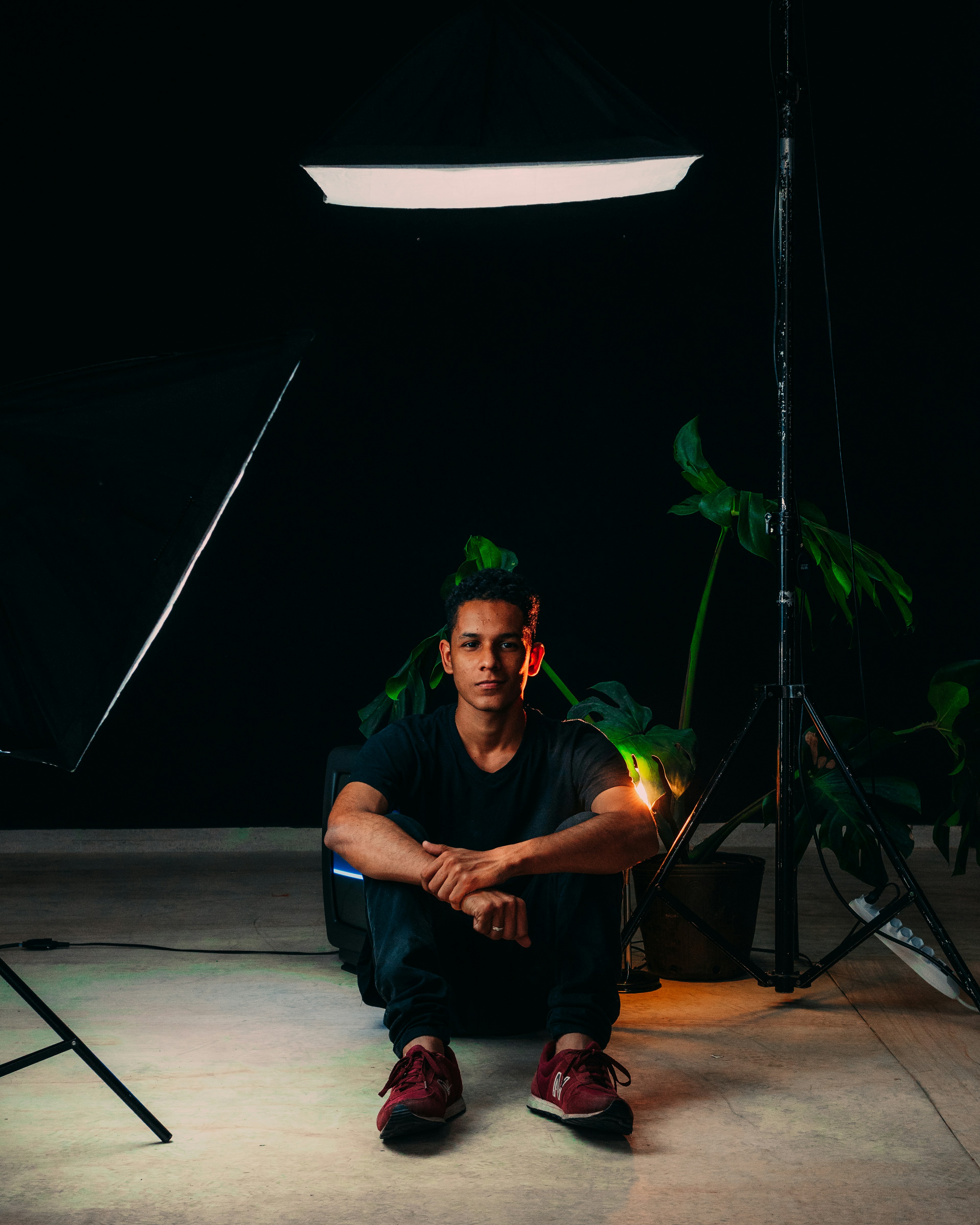 man in black crew neck t-shirt sitting on floor