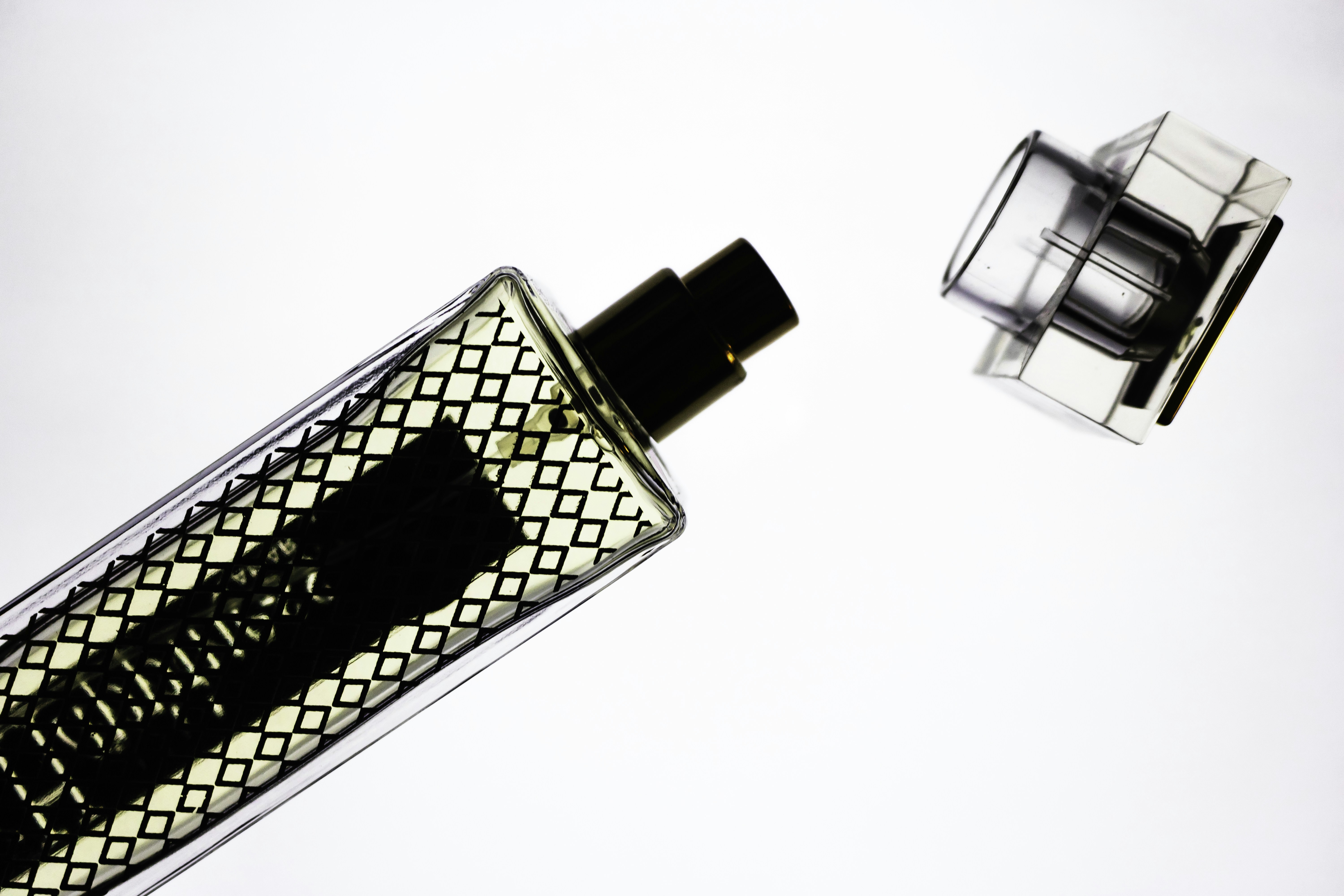 Geometric fragrance: a diamond-pattern bottle with its cap separated