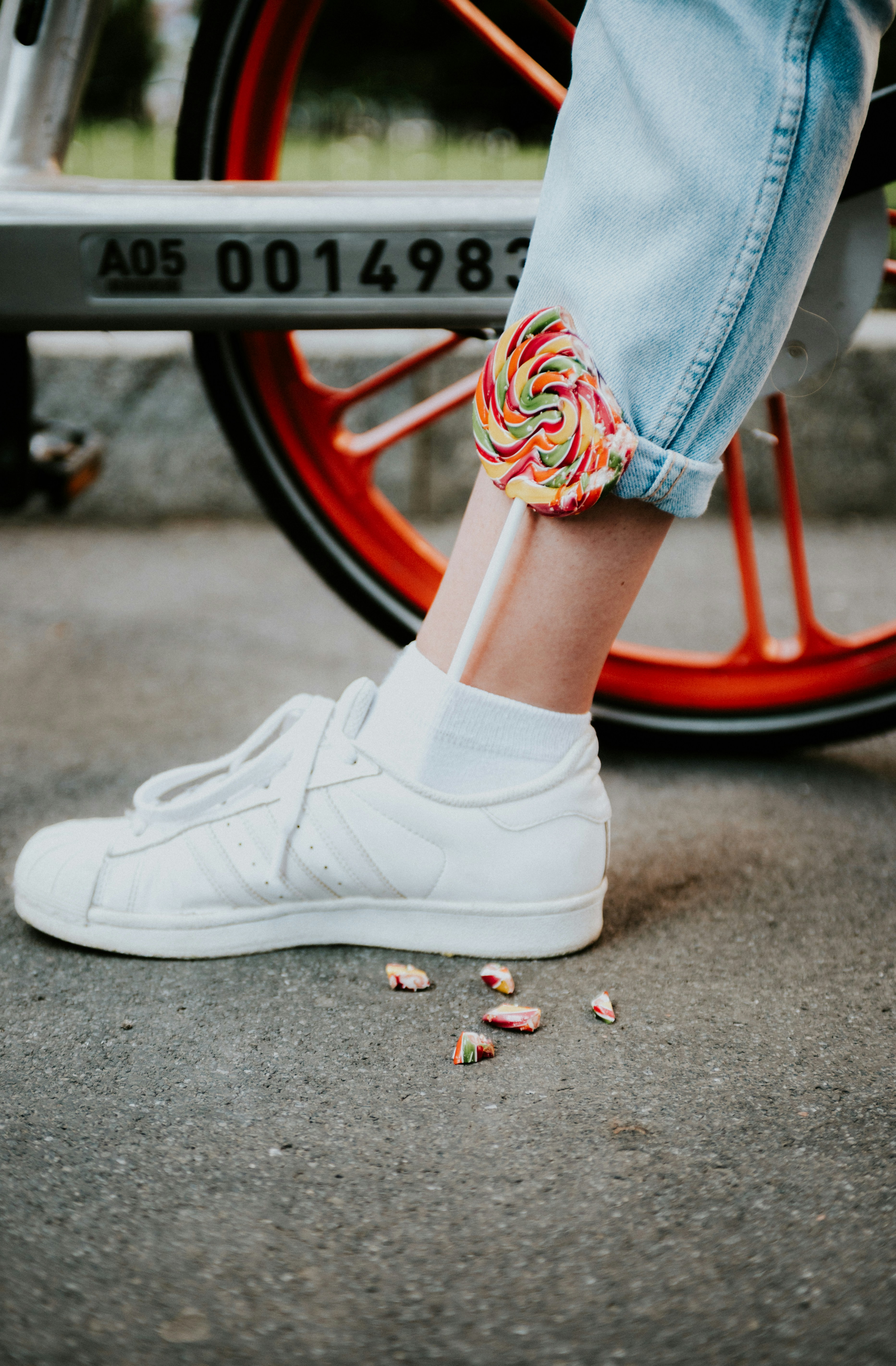 Candy-swirled focus: sneaker, cuff, and bike wheel in motion