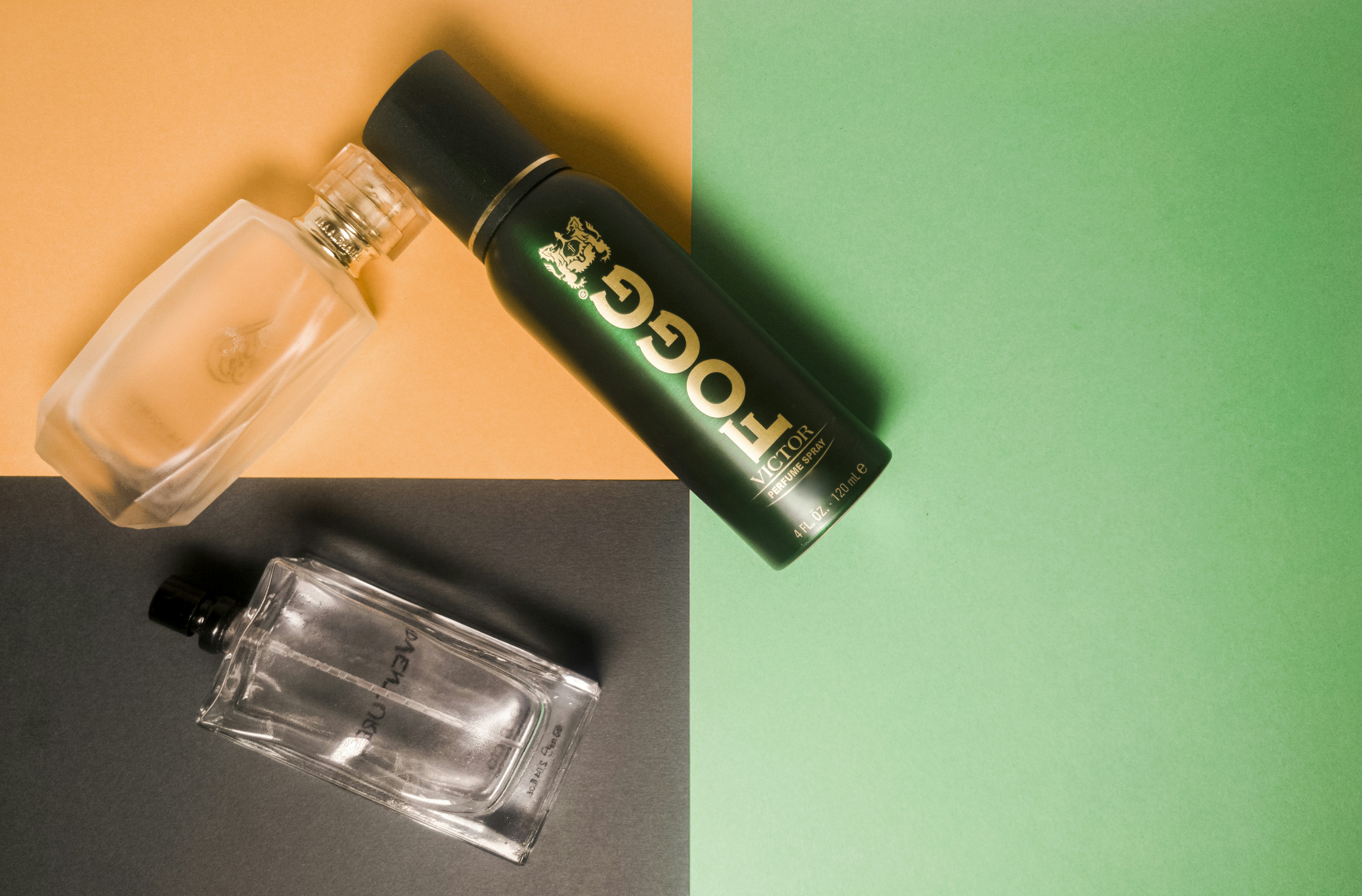 Three distinct fragrance bottles arranged on a vibrant geometric background, showcasing a blend of elegance and modern design.