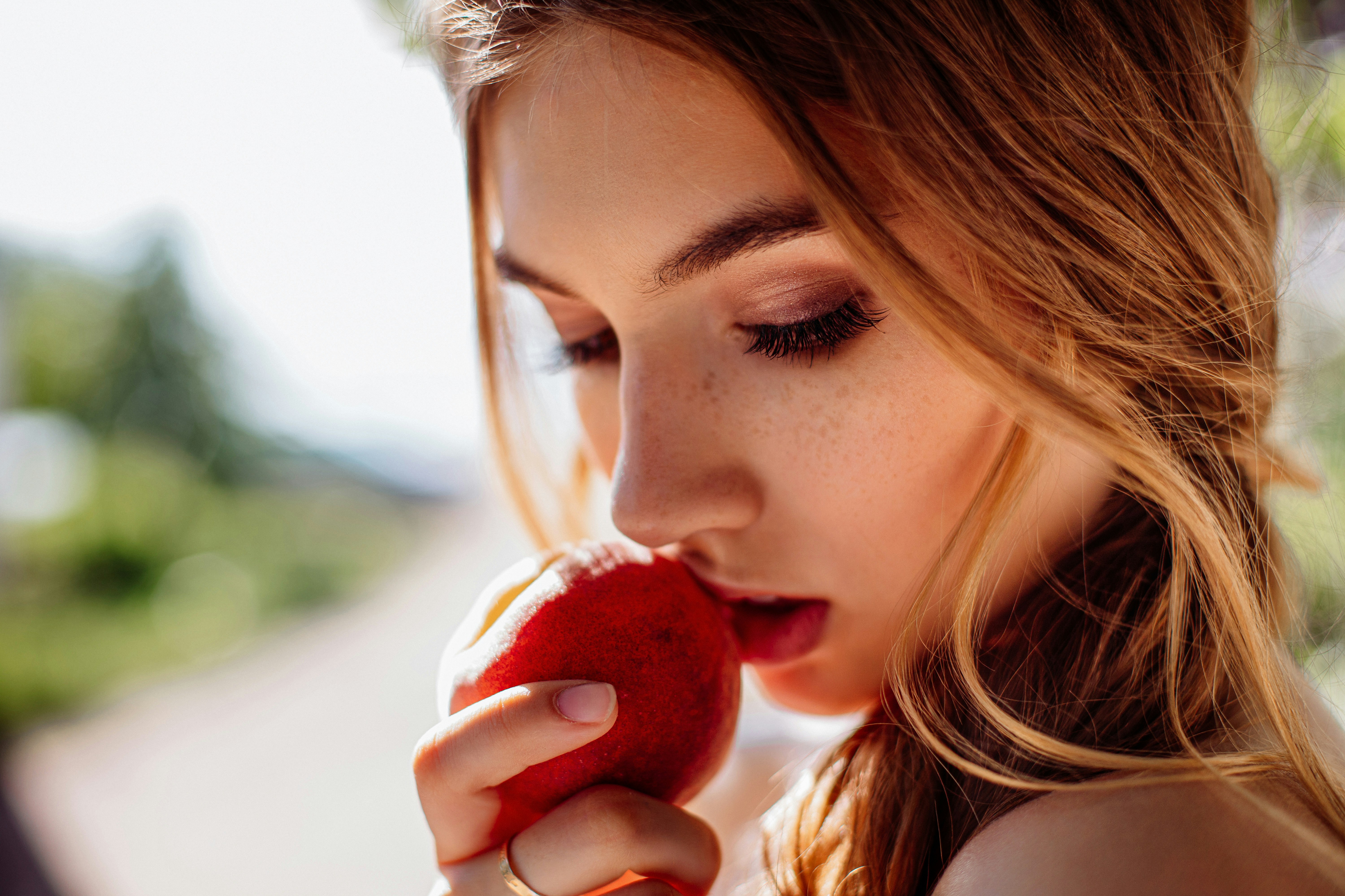 Woman eating red apple during daytime photo – Free Sea Image on Unsplash