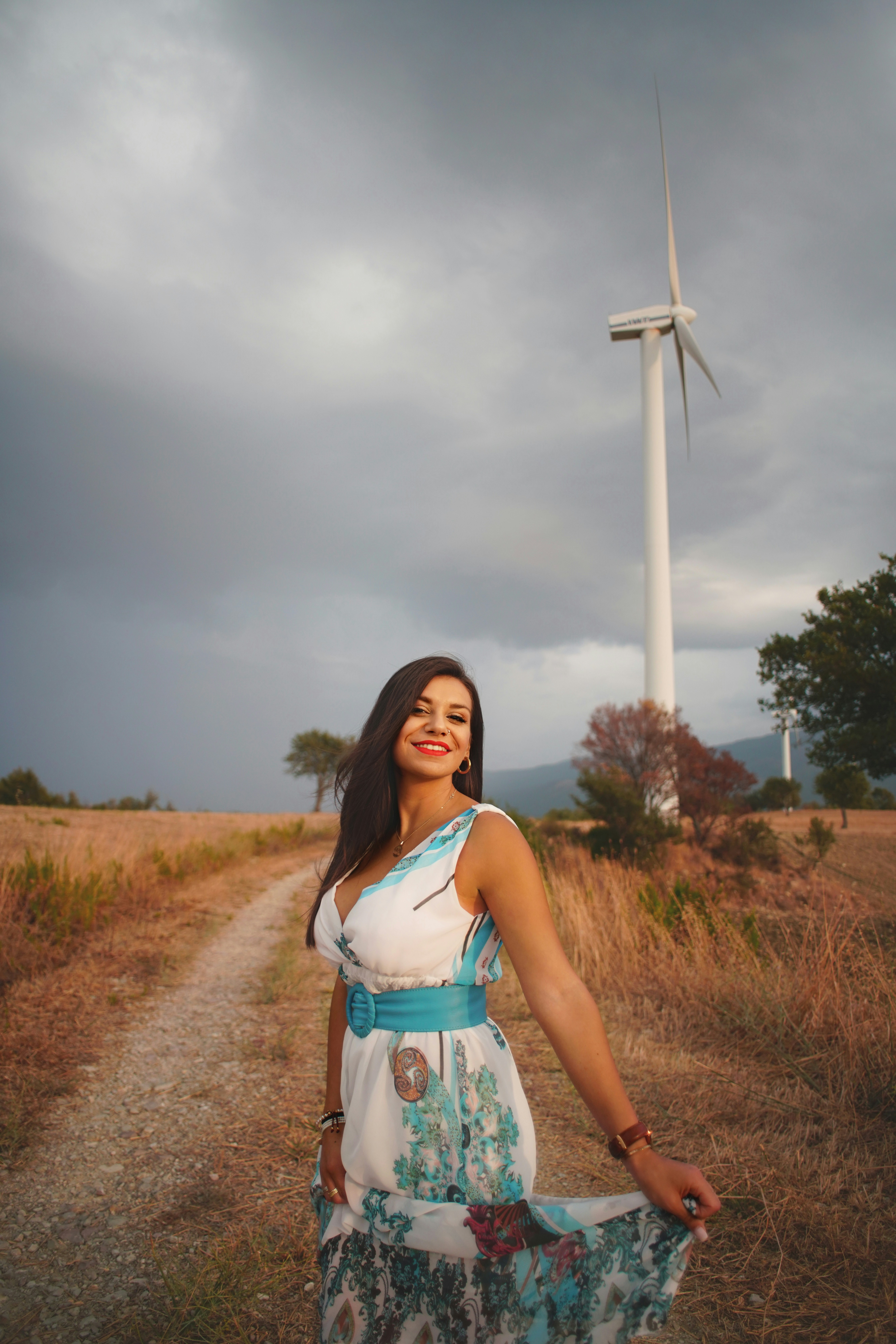 Portrait on a Gravel Road Under the Wind Turbine