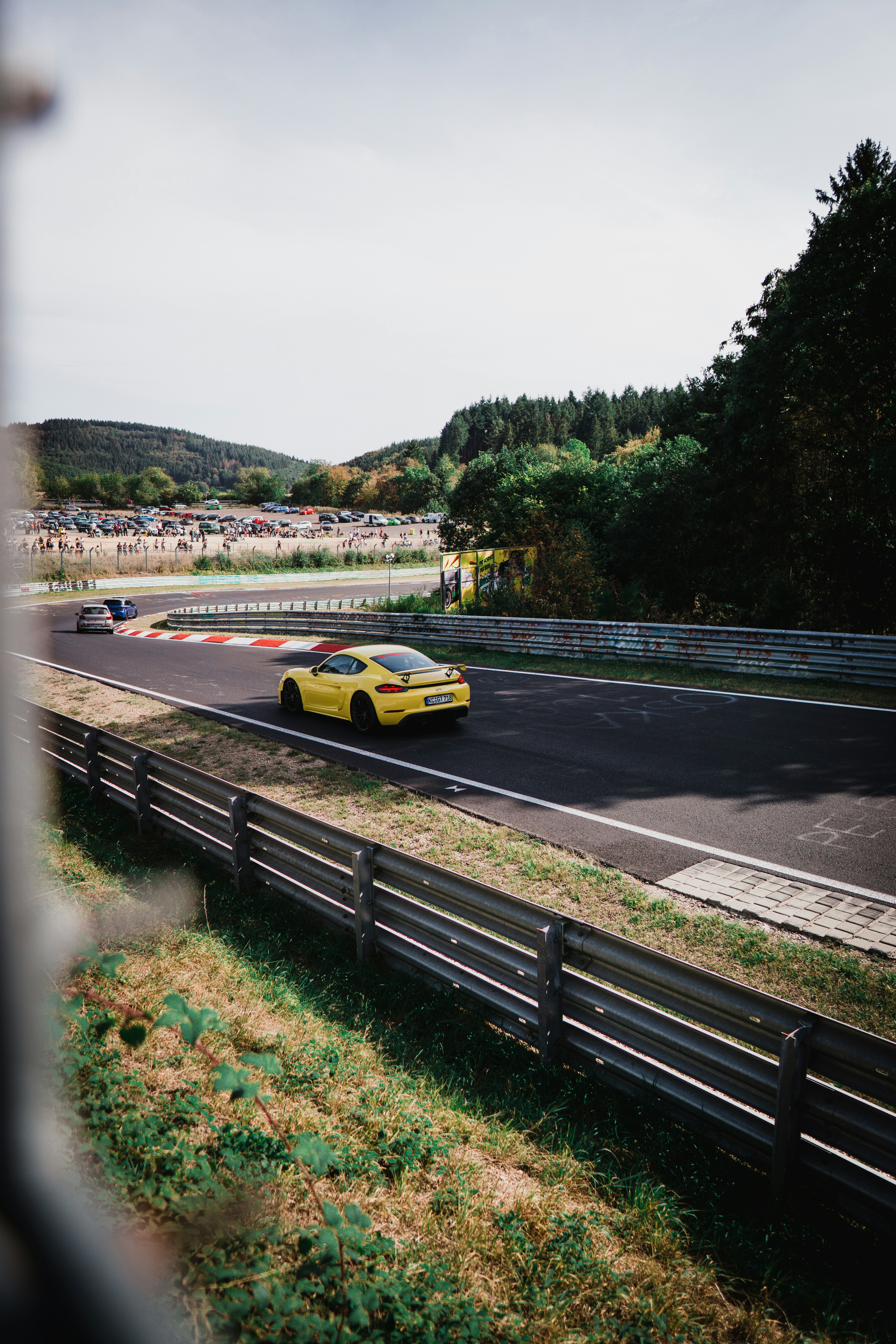 Yellow Porsche on a Race Track: A Moment Amid Curves and Guardrails