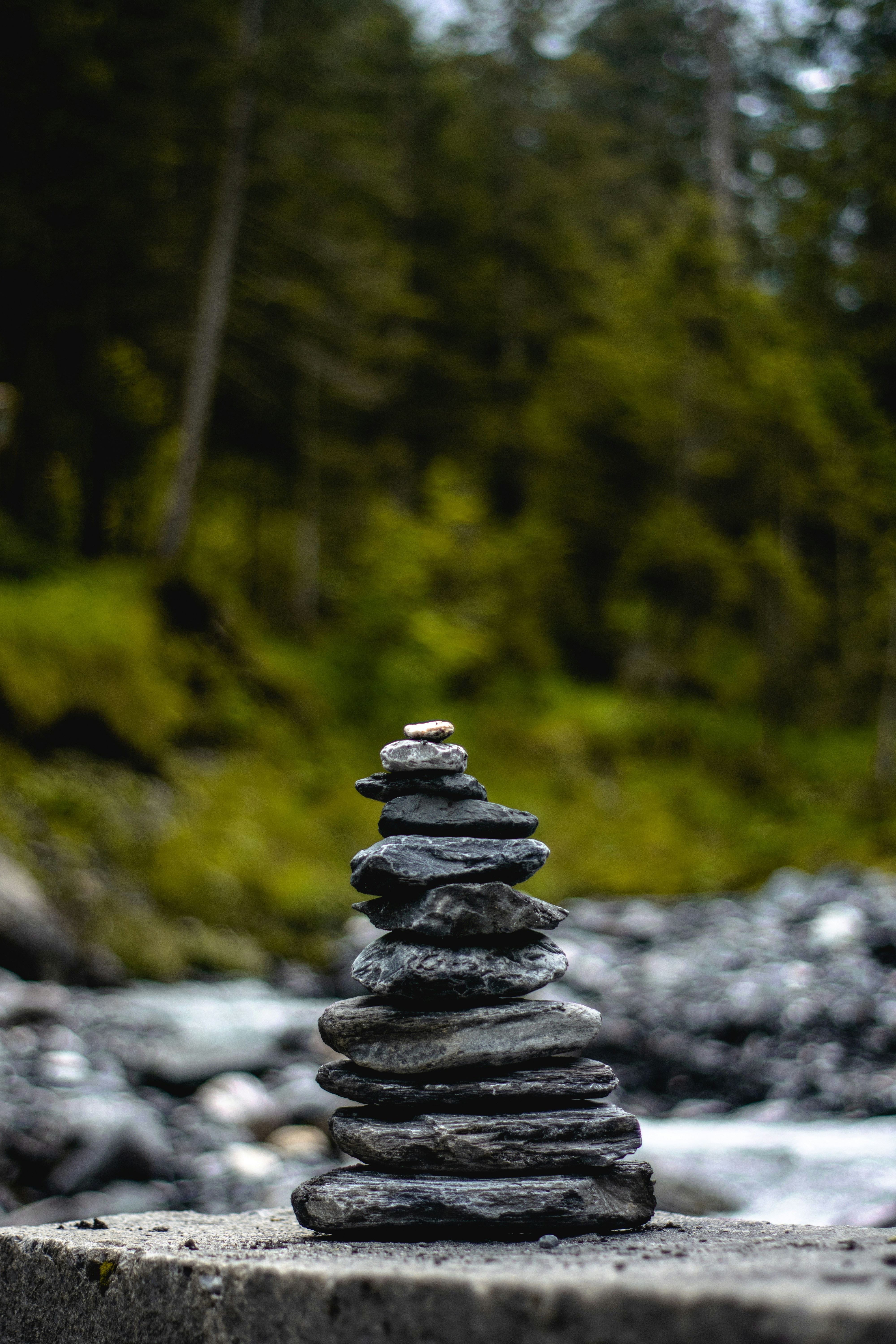 Stacked stones create a harmonious focal point against a blurred natural backdrop. The arrangement symbolizes tranquility and balance.