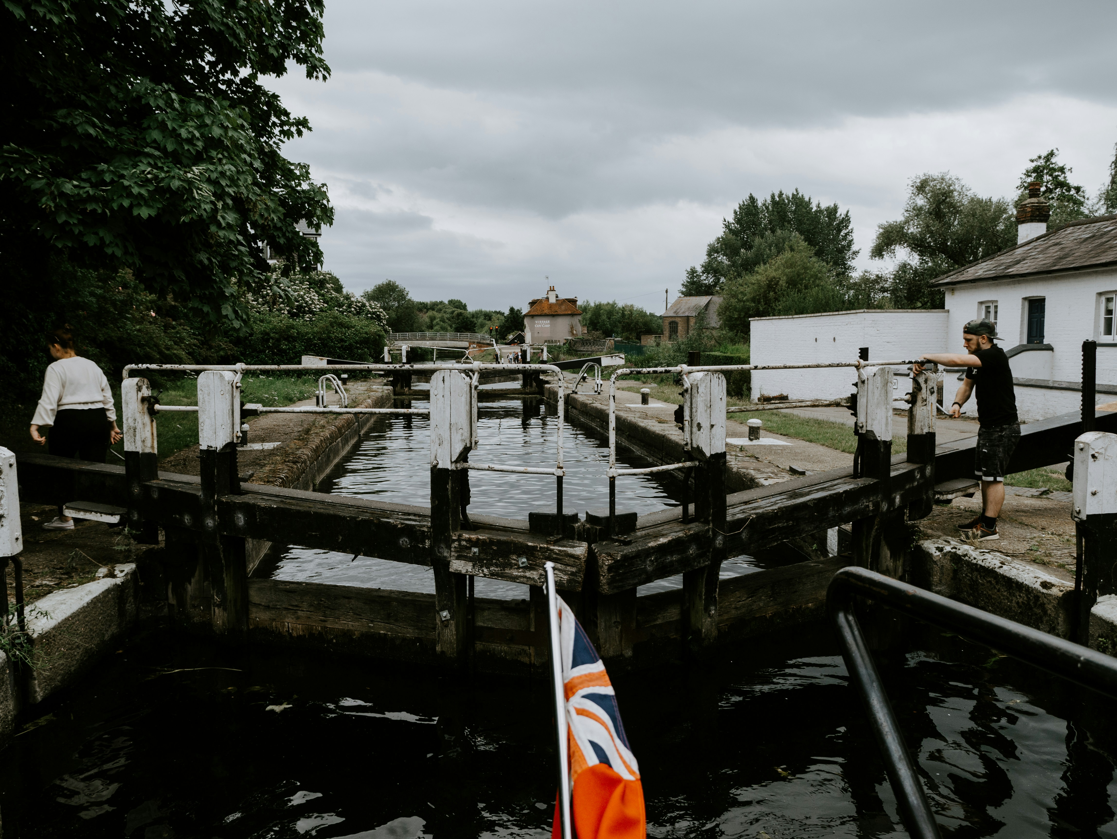 white and red flag on wooden dock during daytime