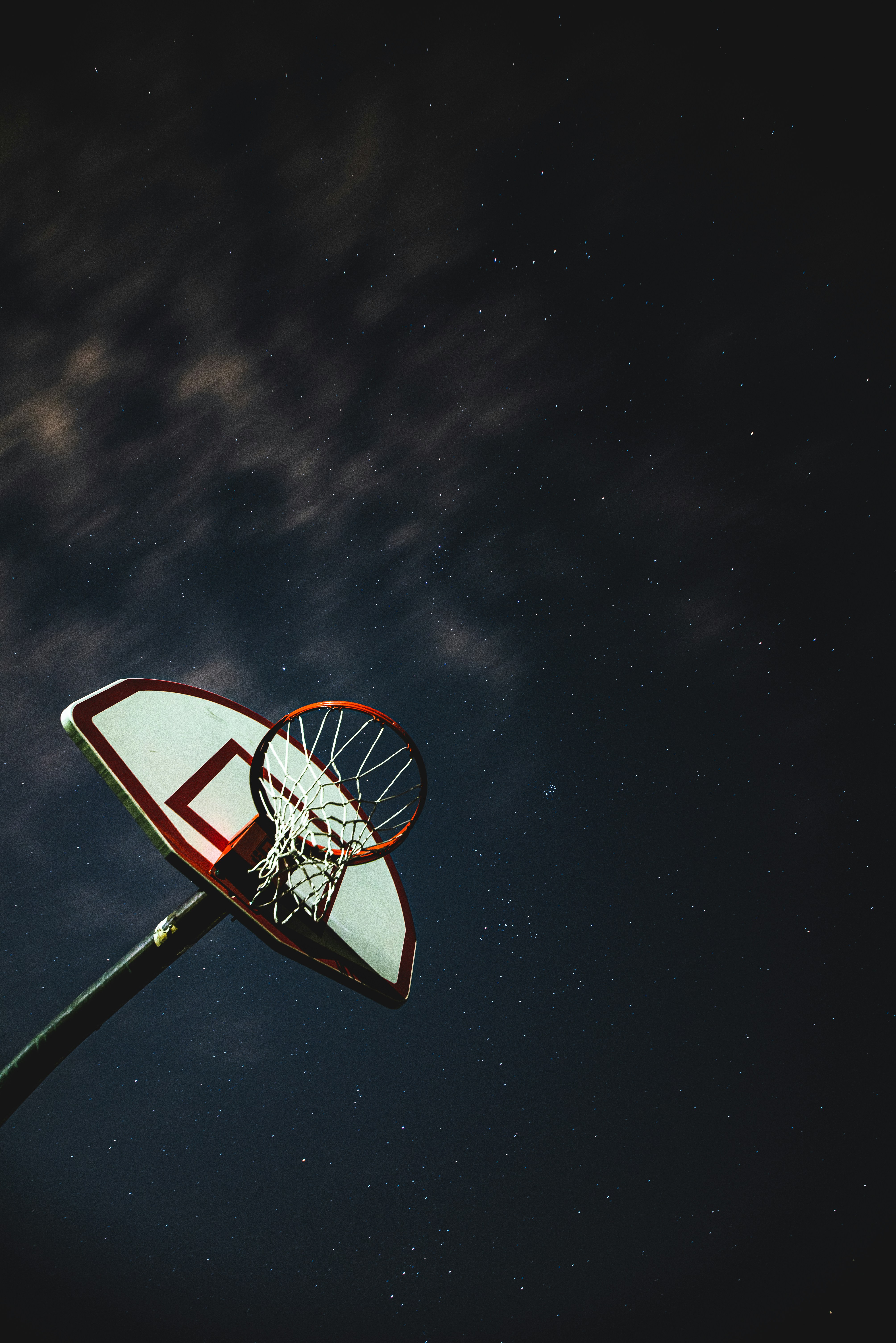 Starlit Hoop: A solitary basketball rim against a velvet night sky