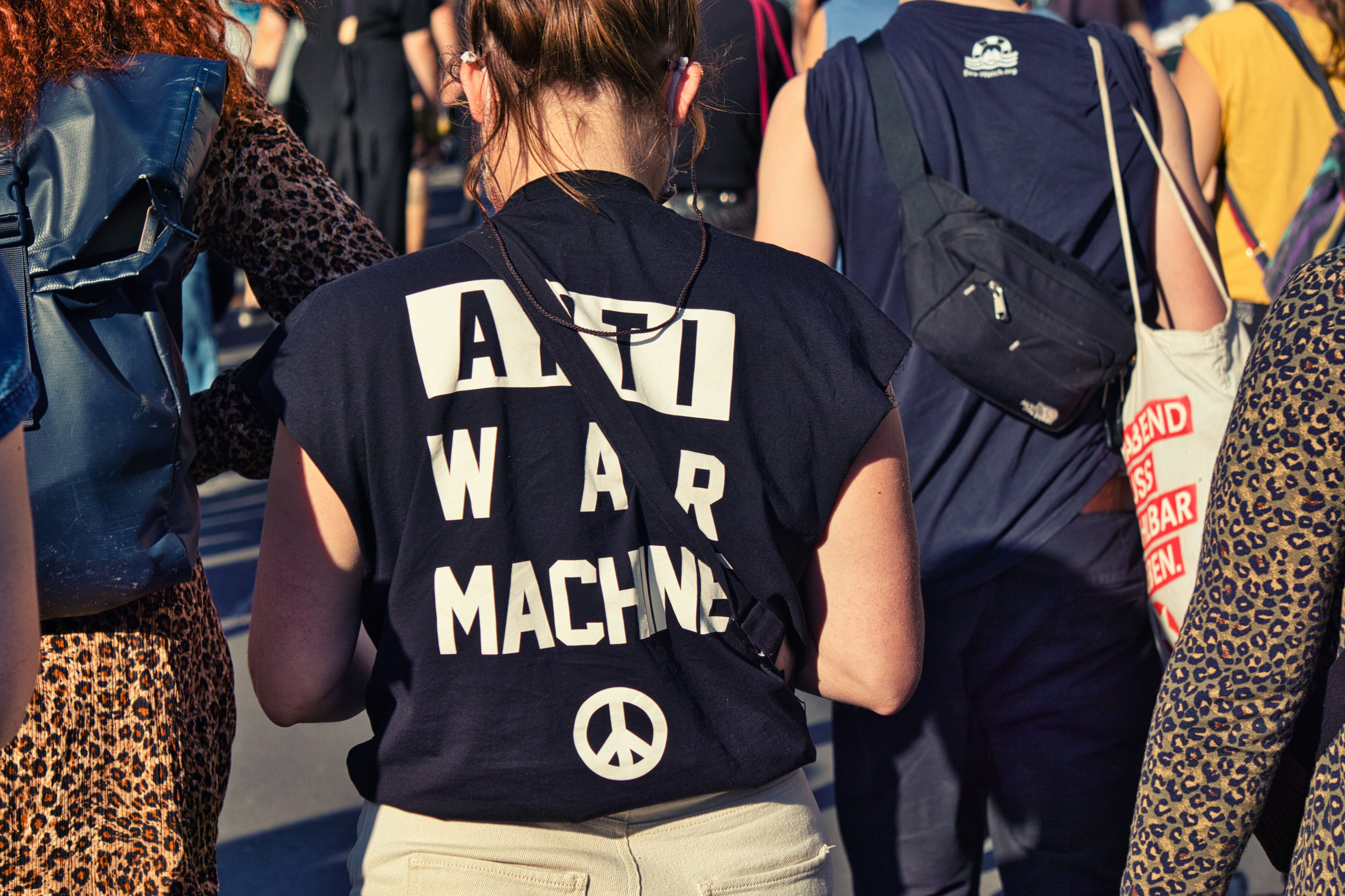 Back View at the Marching Crowd: 'AWAR MACHINE' Tee and Peace SymbolMoises Gonzalez