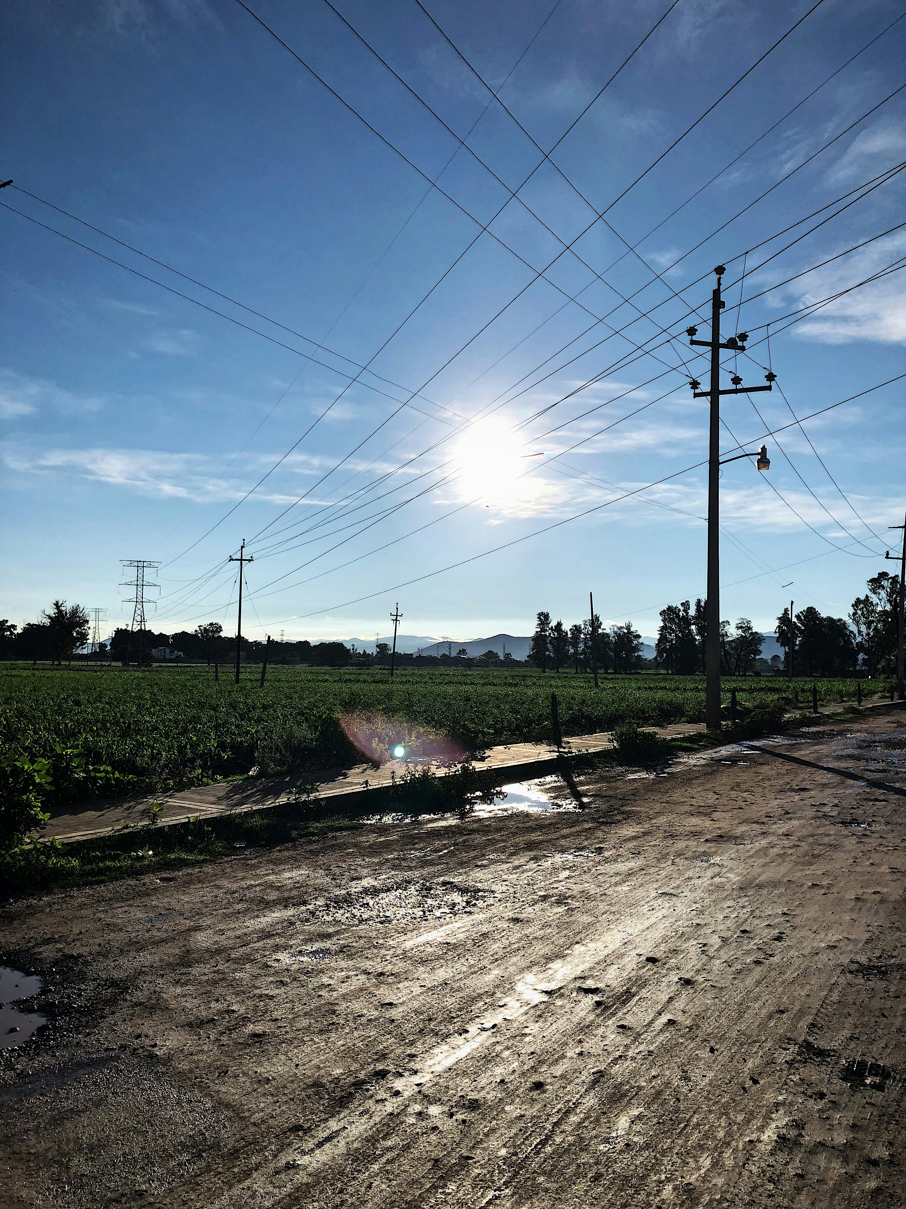 Gray electric post near green grass field during daytime photo – Free ...