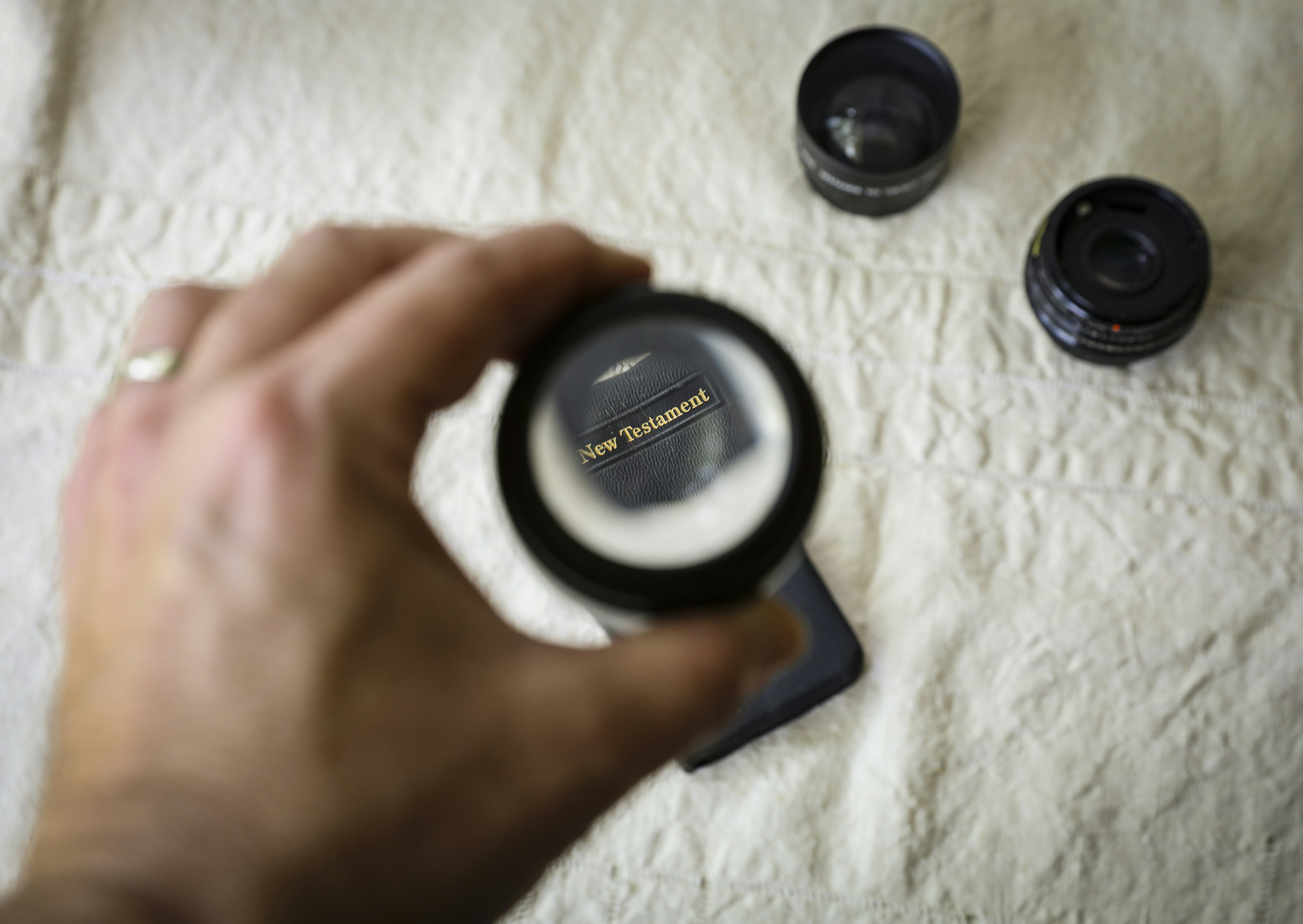 An old telephoto lens tube provides the focus onto my grandfather's old pocket New Testament.