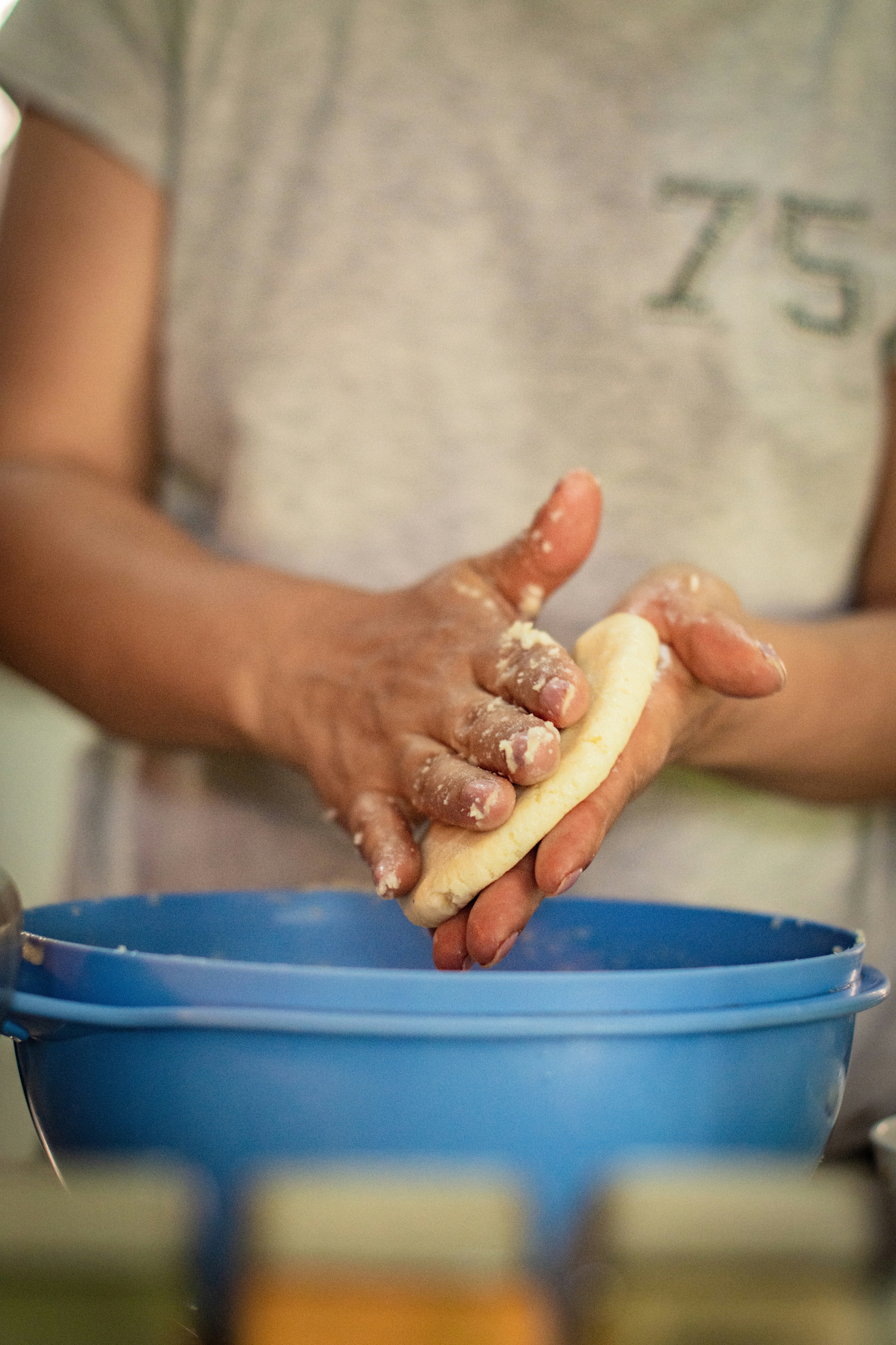 person holding blue plastic bucket