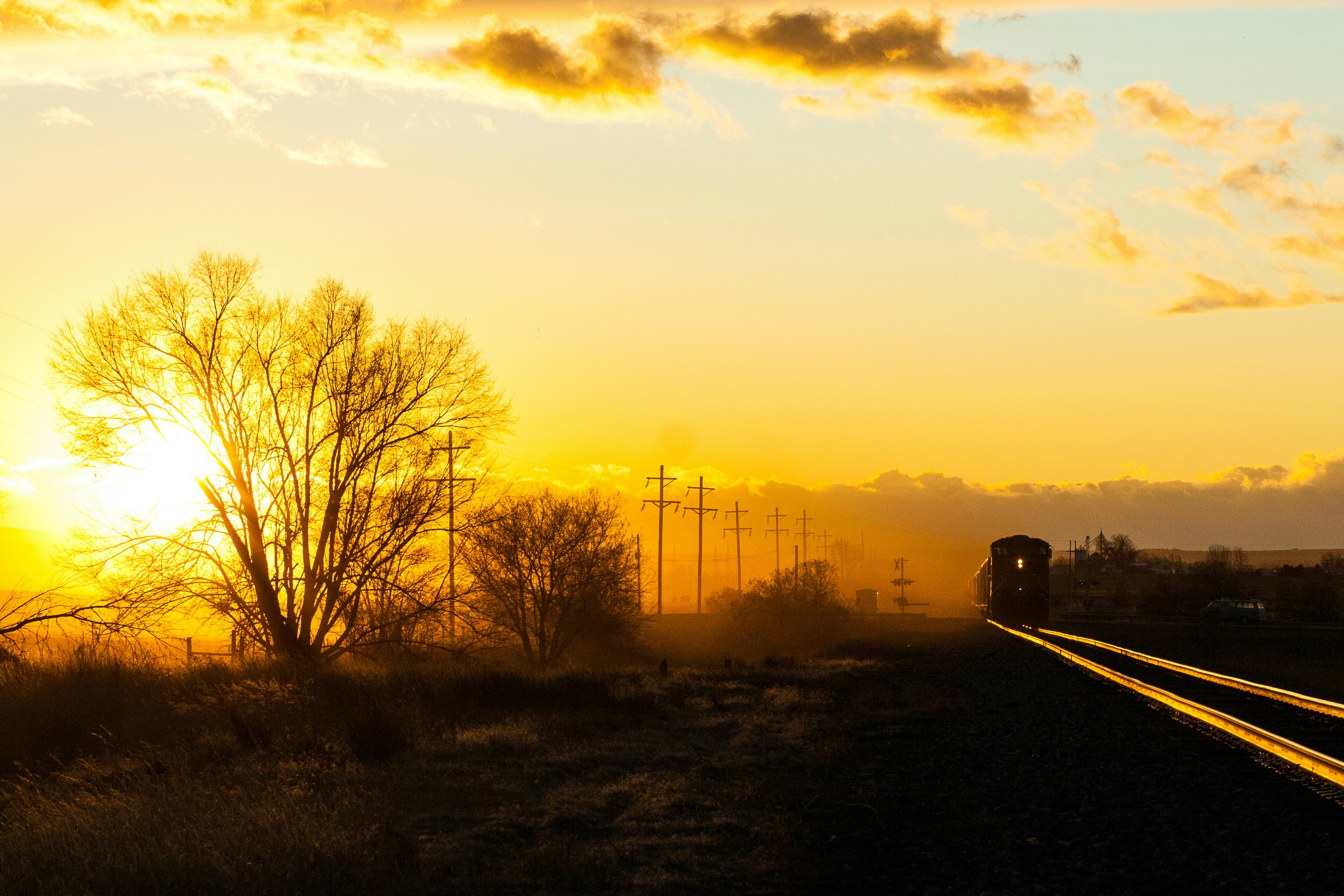 Sunrise on the Quiet Rails: A Backlit Dawn by the Tracks