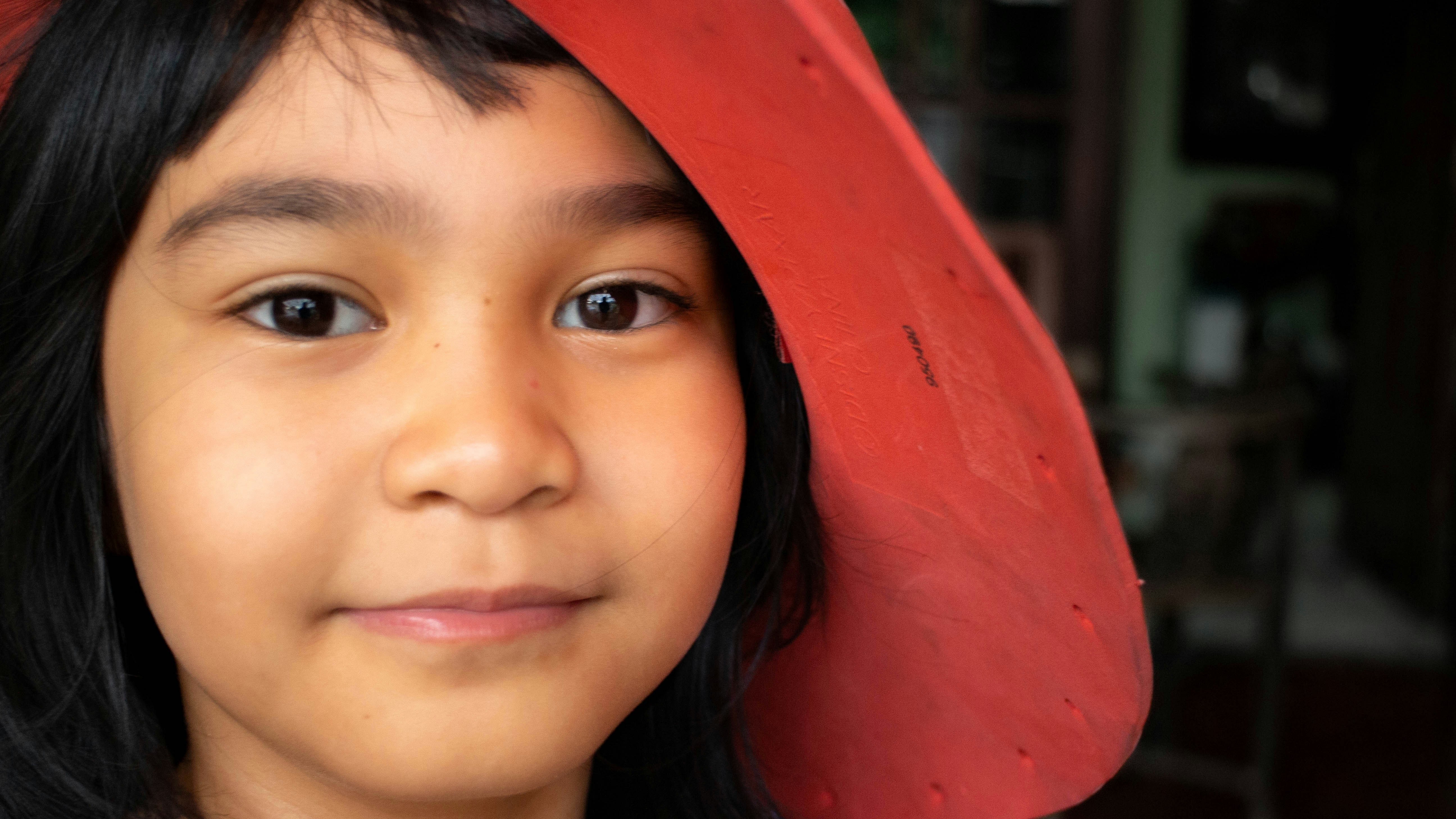 girl with red hat smiling