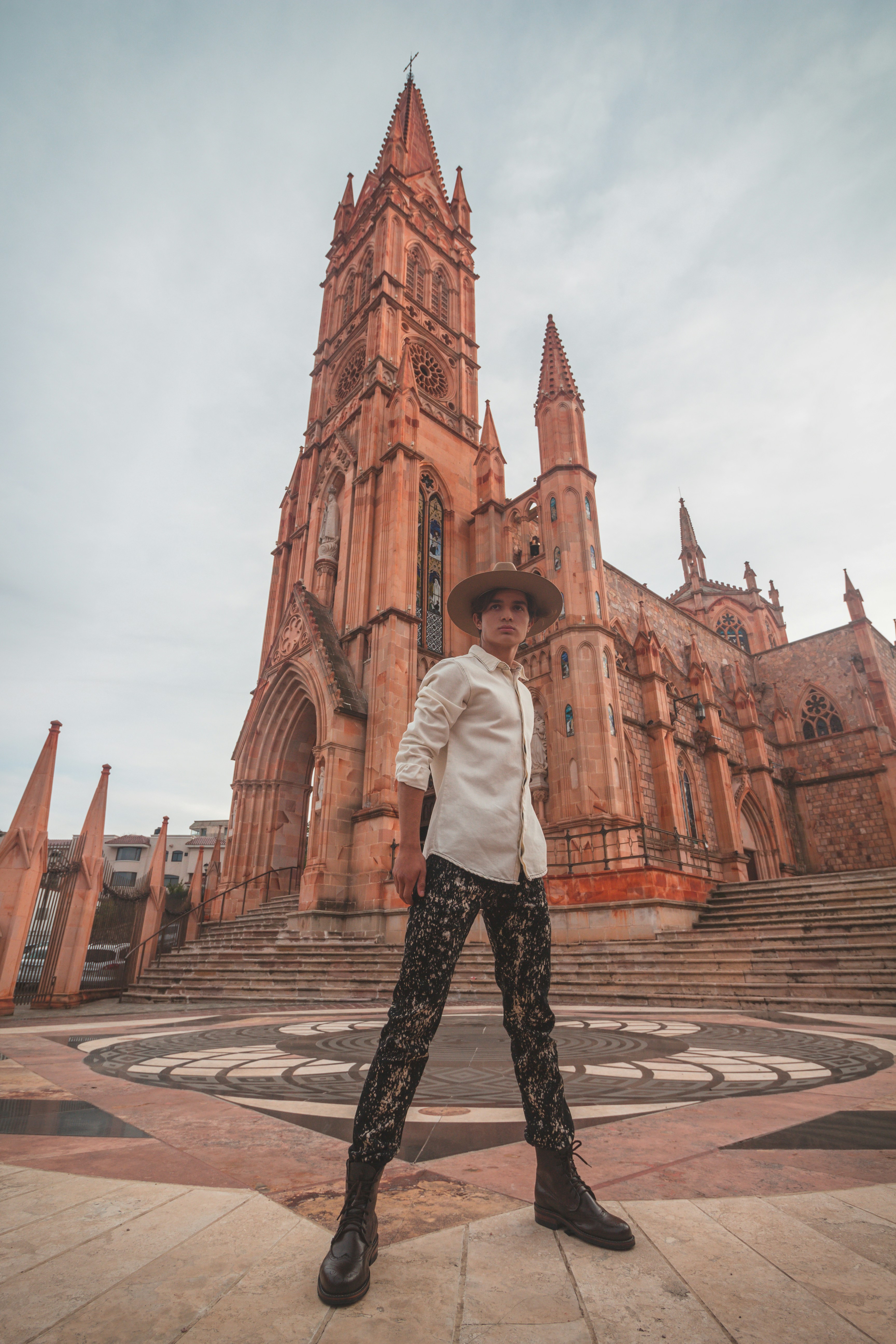 Lofty Gothic Steps: A Traveler Stands Before the Cathedral Spires