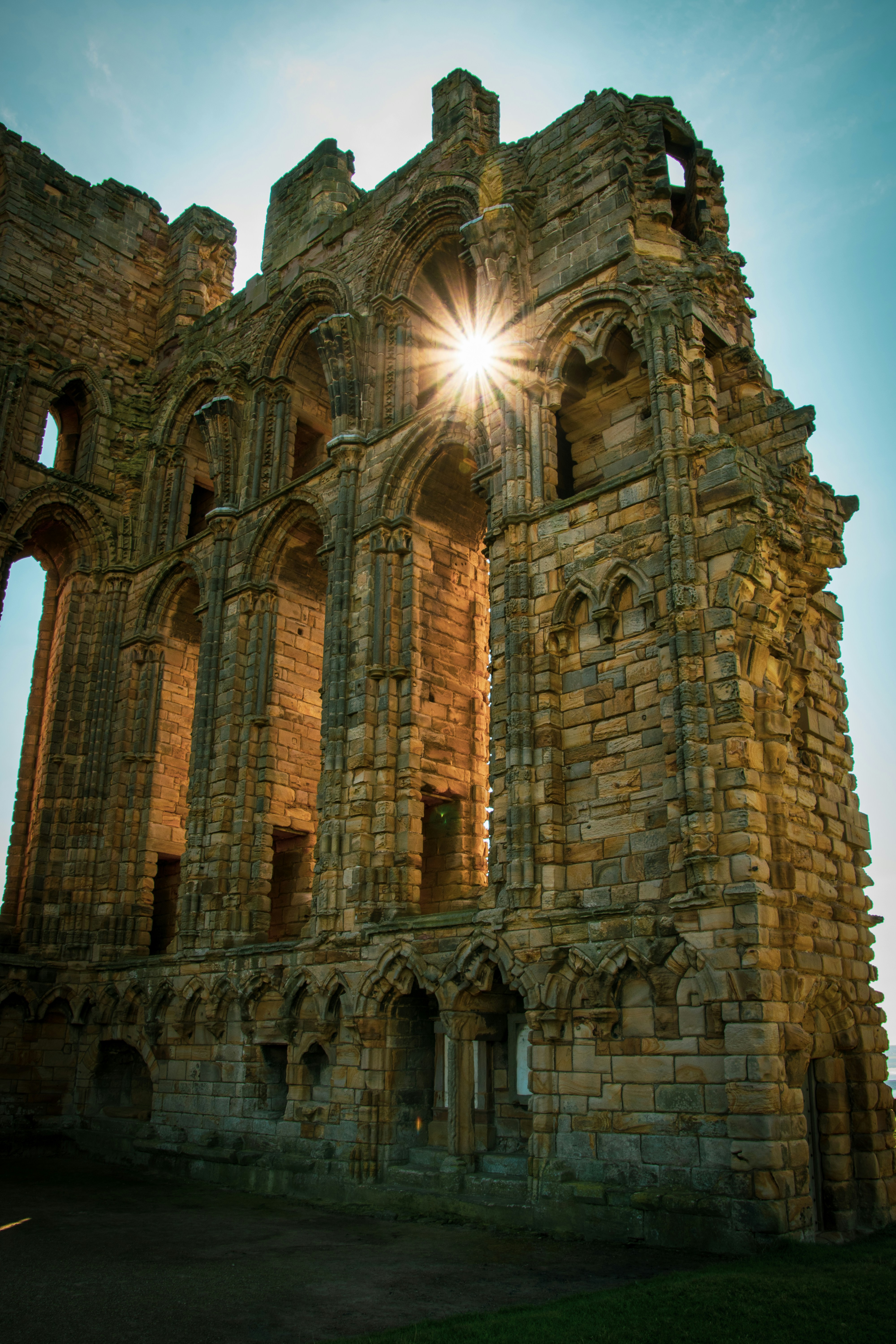 Sunburst Through Ancient Arches: A Sepia-Hued Ruin at Dusk
