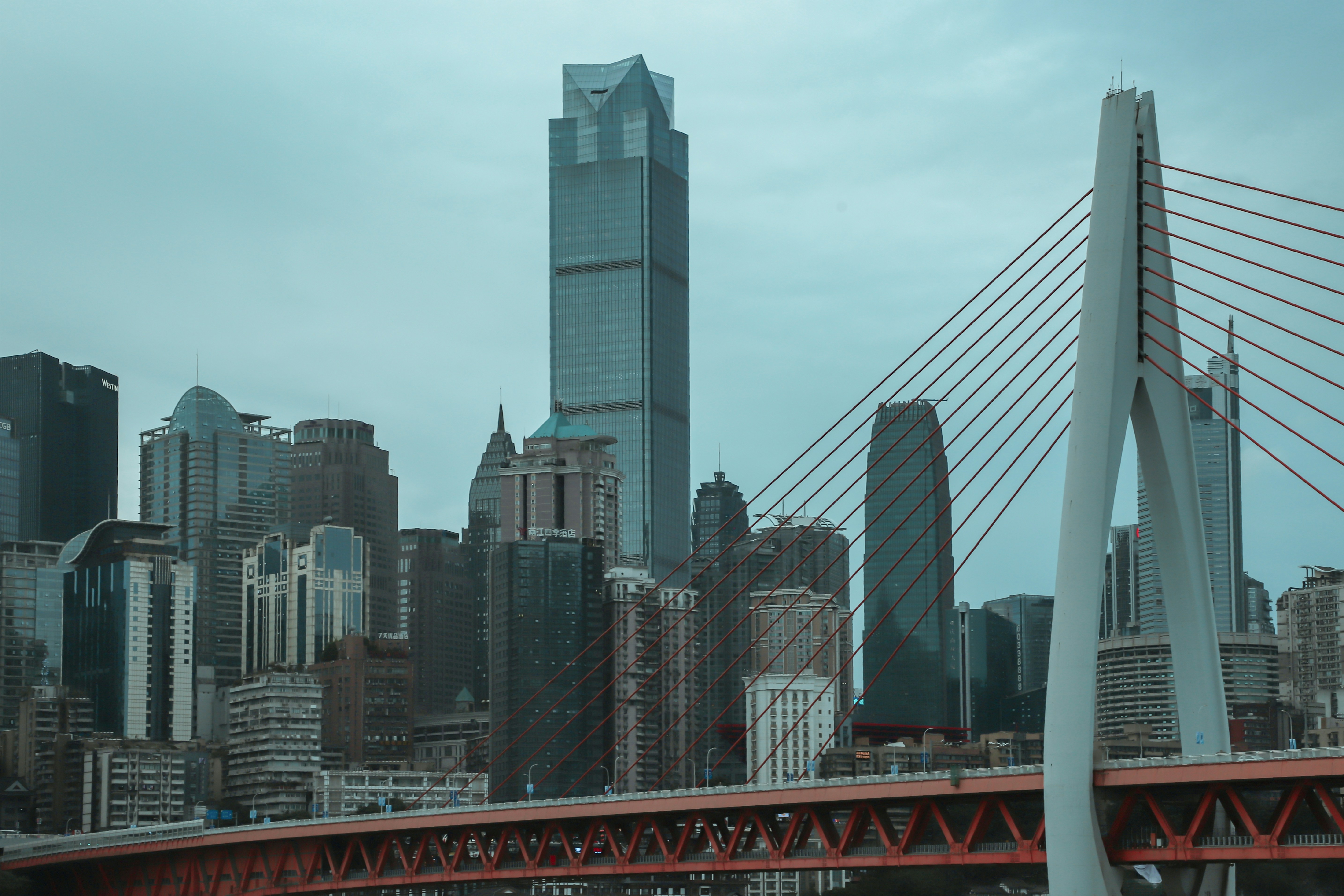 Red metal bridge across city buildings during daytime photo – Free ...