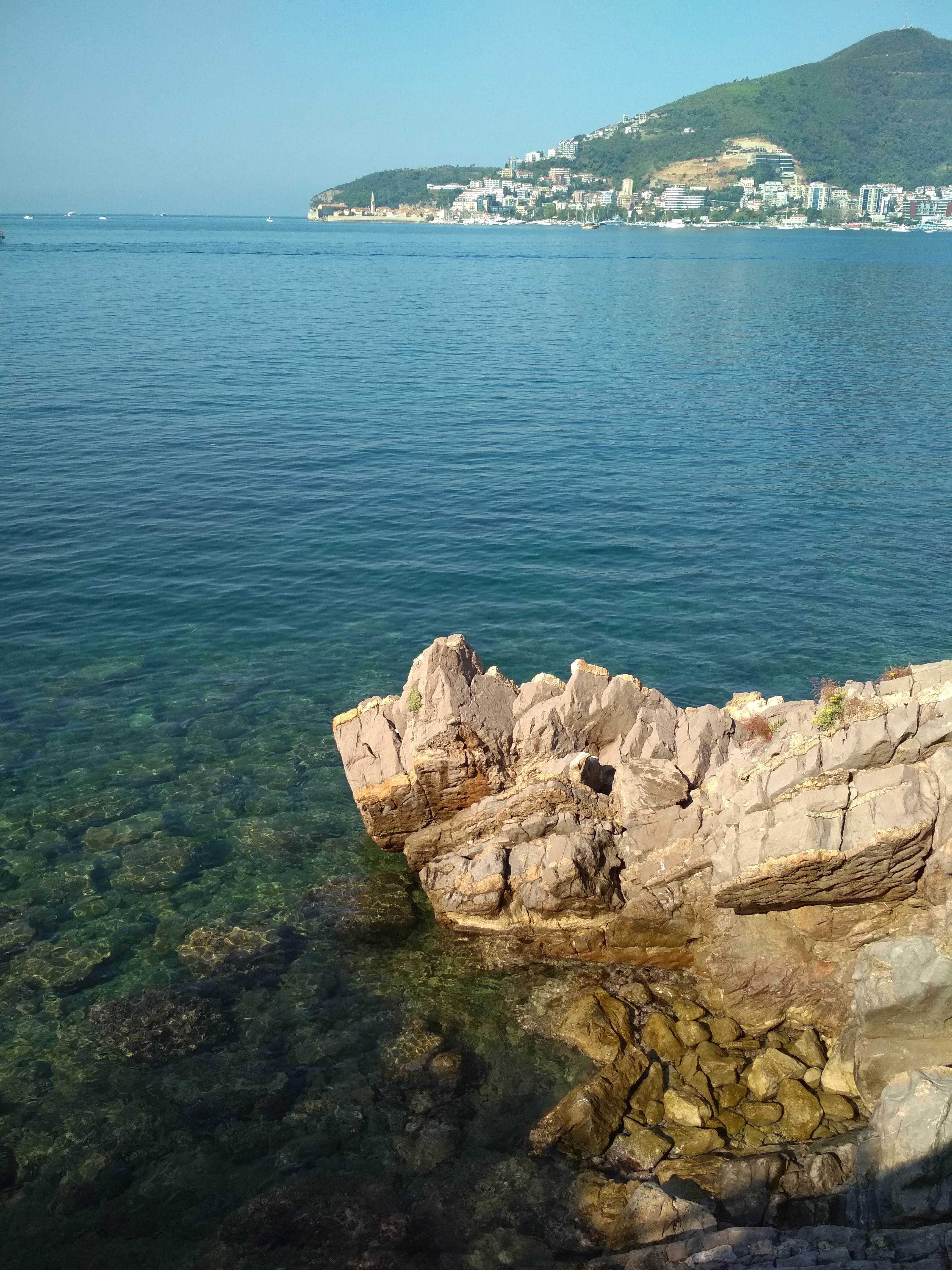 Brown rock formation near body of water during daytime photo – Free ...