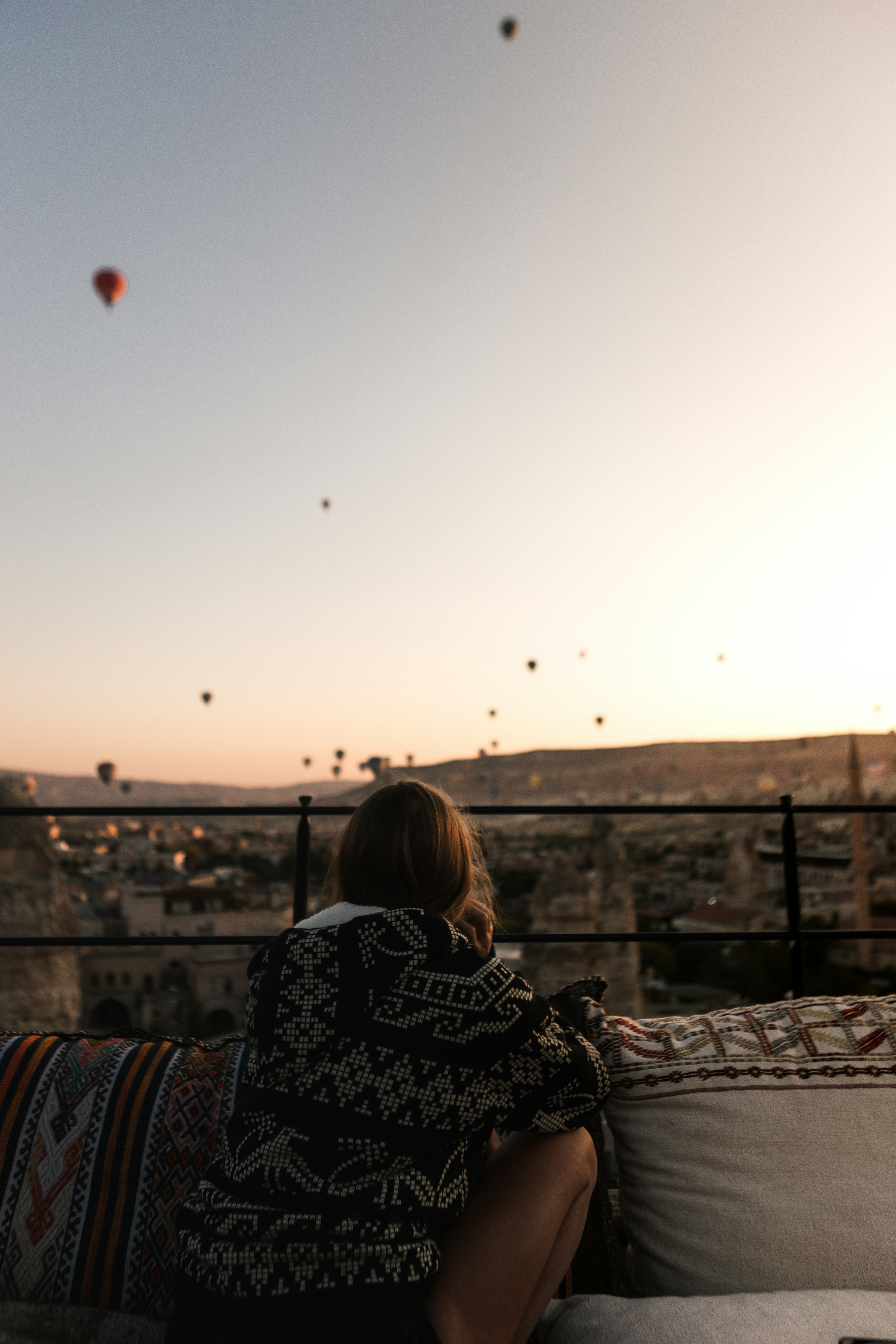 Balloons at Dusk: A Quiet Balcony Moment Above the City
