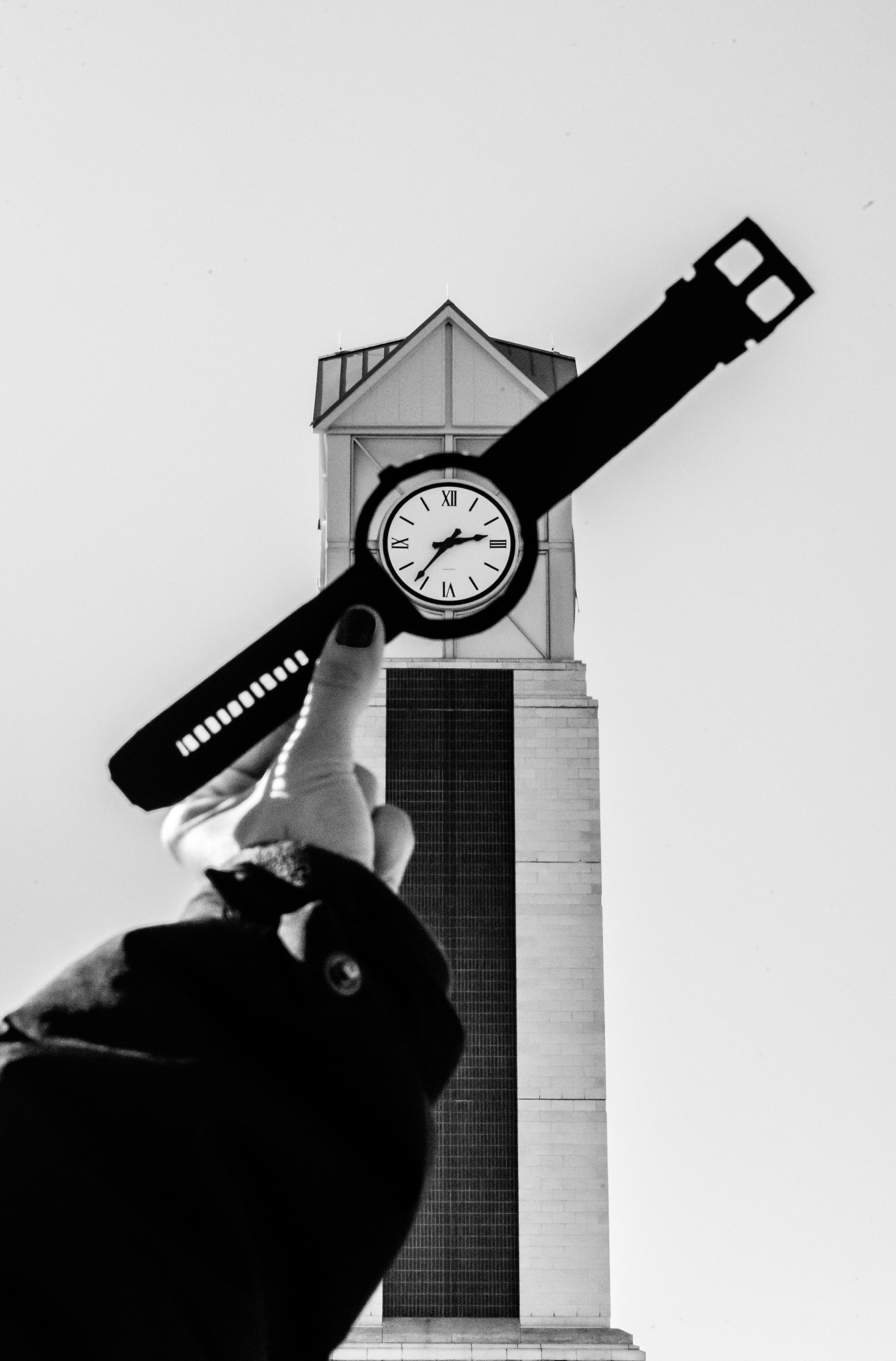 Hands and Hours: A monochrome duel between a wristwatch and a clock tower