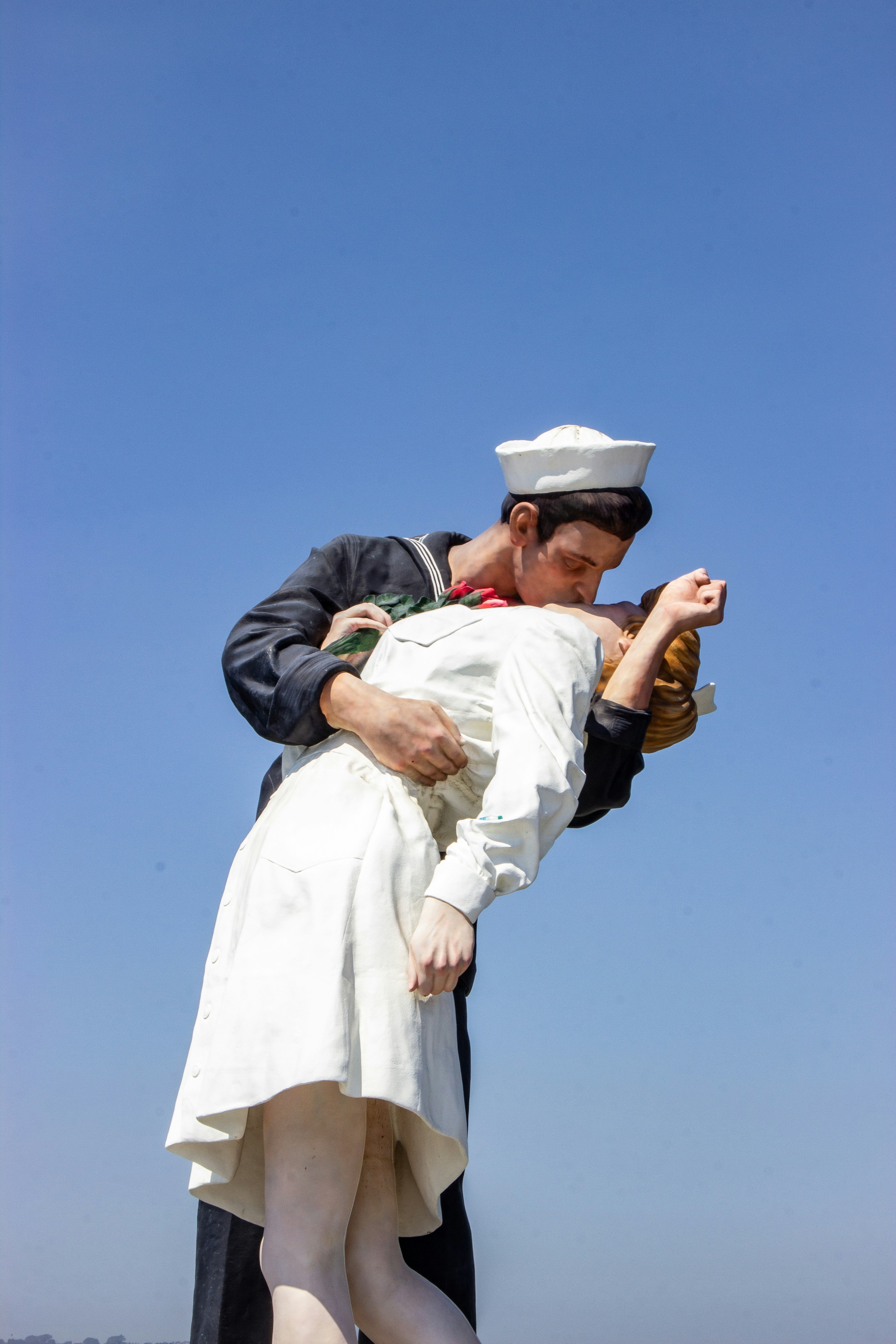 PDA | man in white dress shirt and black jacket holding man in black jacket