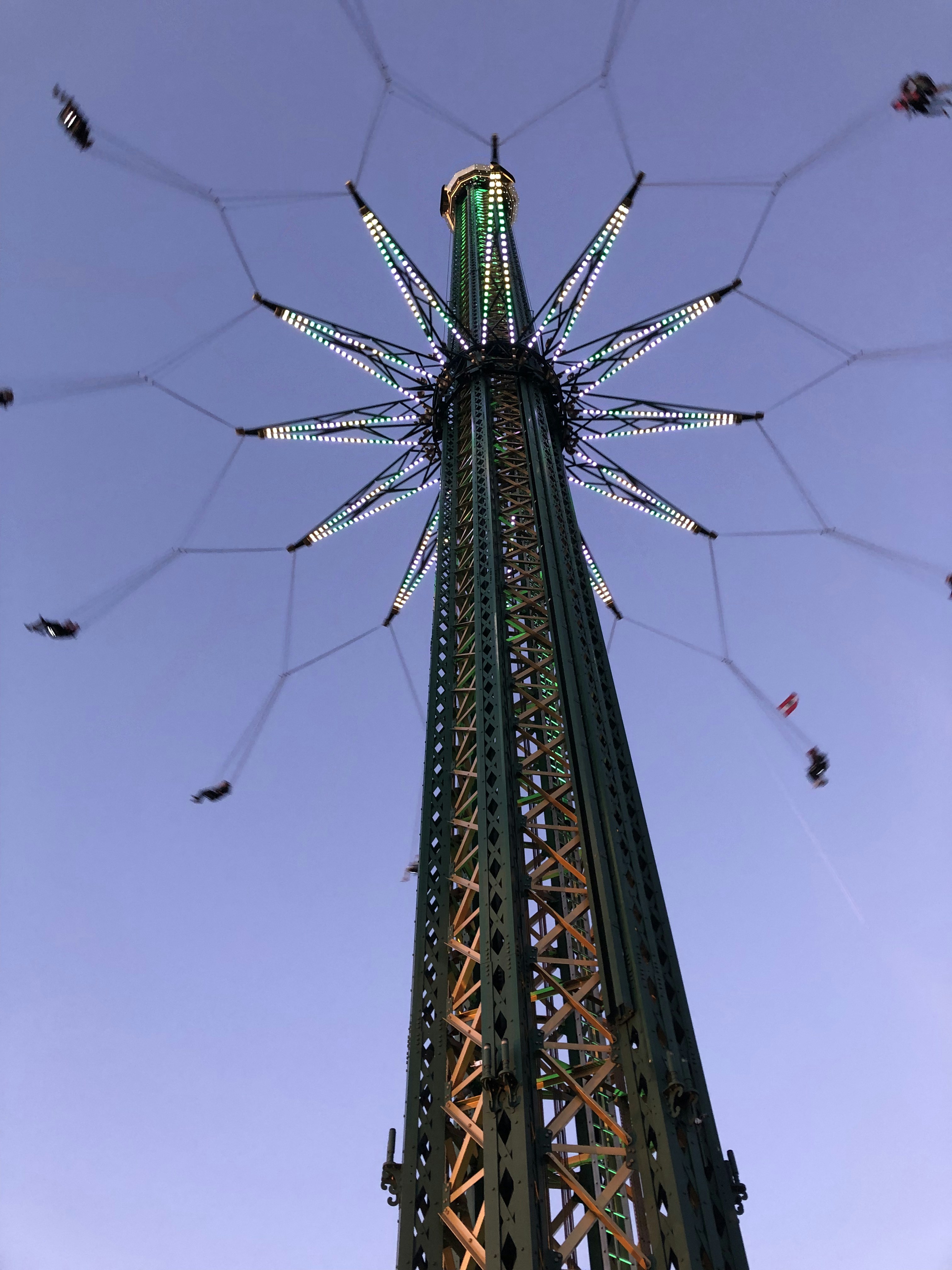 Starburst Ascend: Upward Perspective of the Swing Tower Against a Twilight Sky