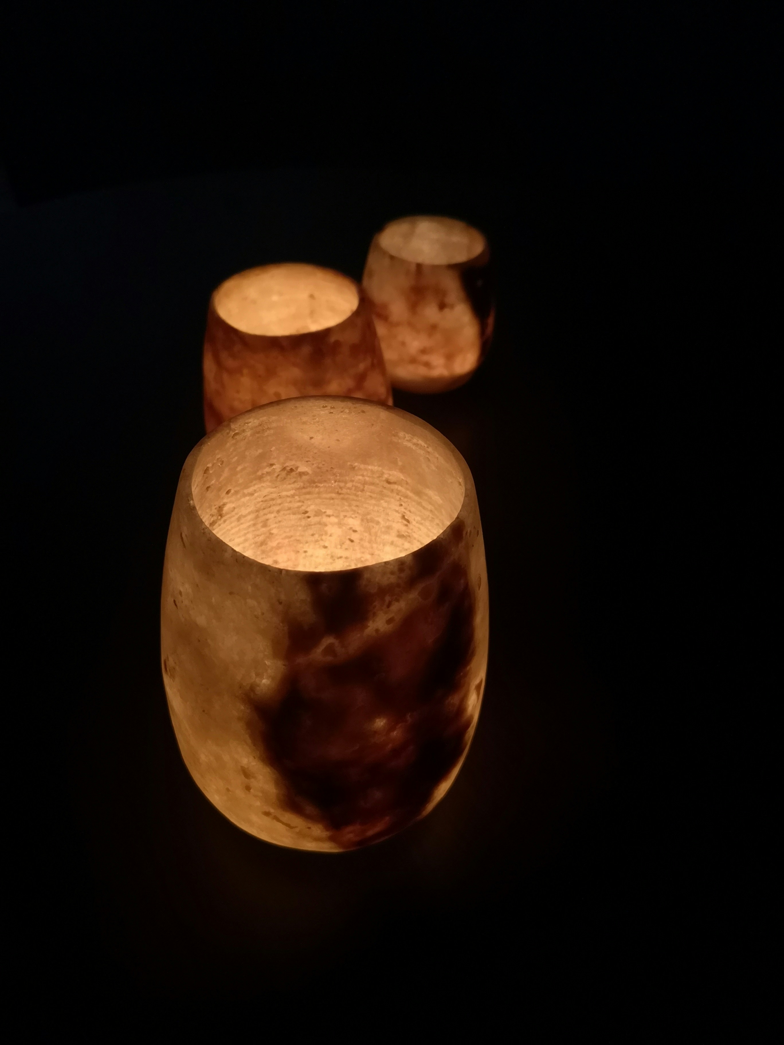 Amber Orbs in Velvet Darkness: A Trio of Candlelit Vessels