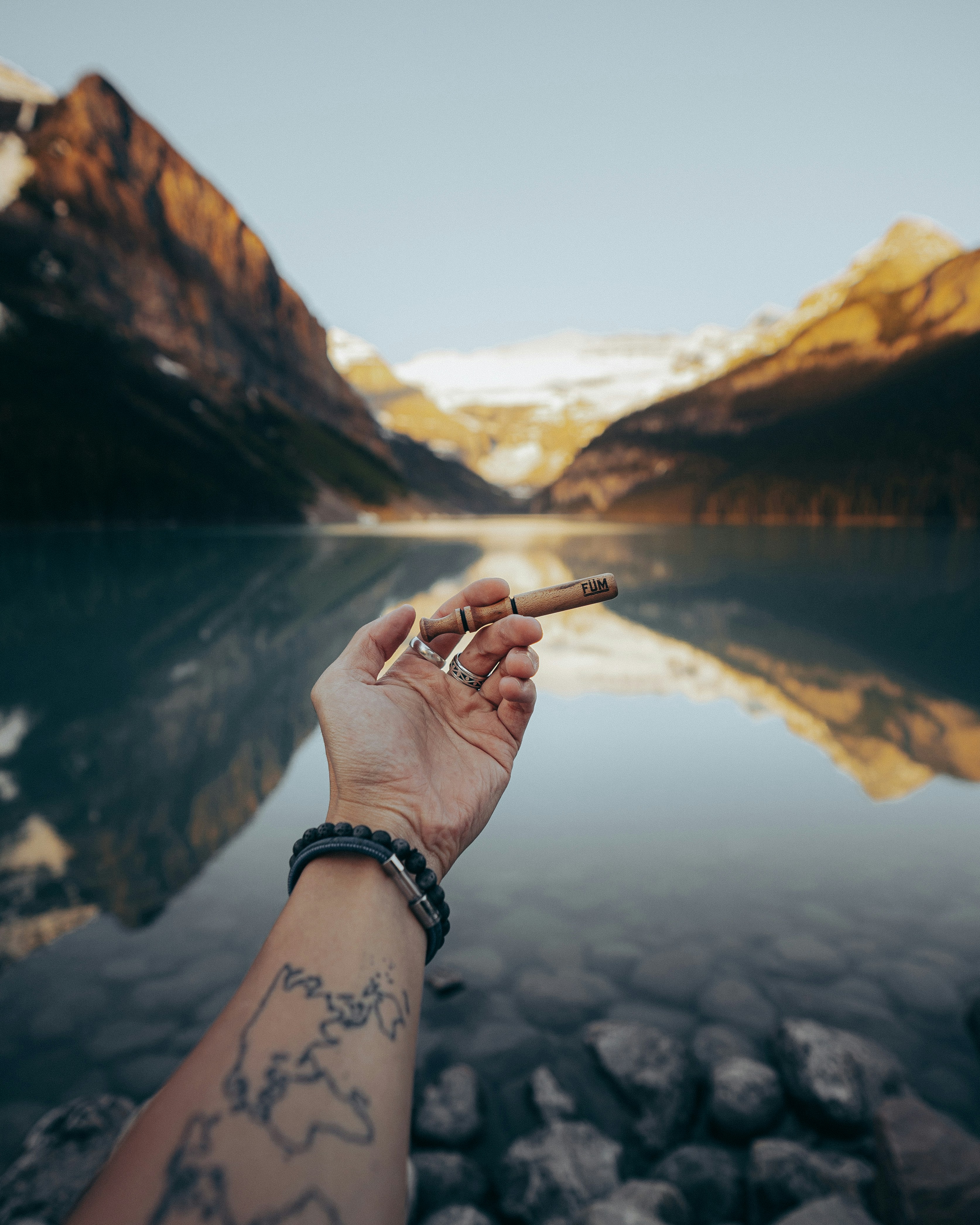Person holding cigarette stick near lake during daytime photo – Free ...