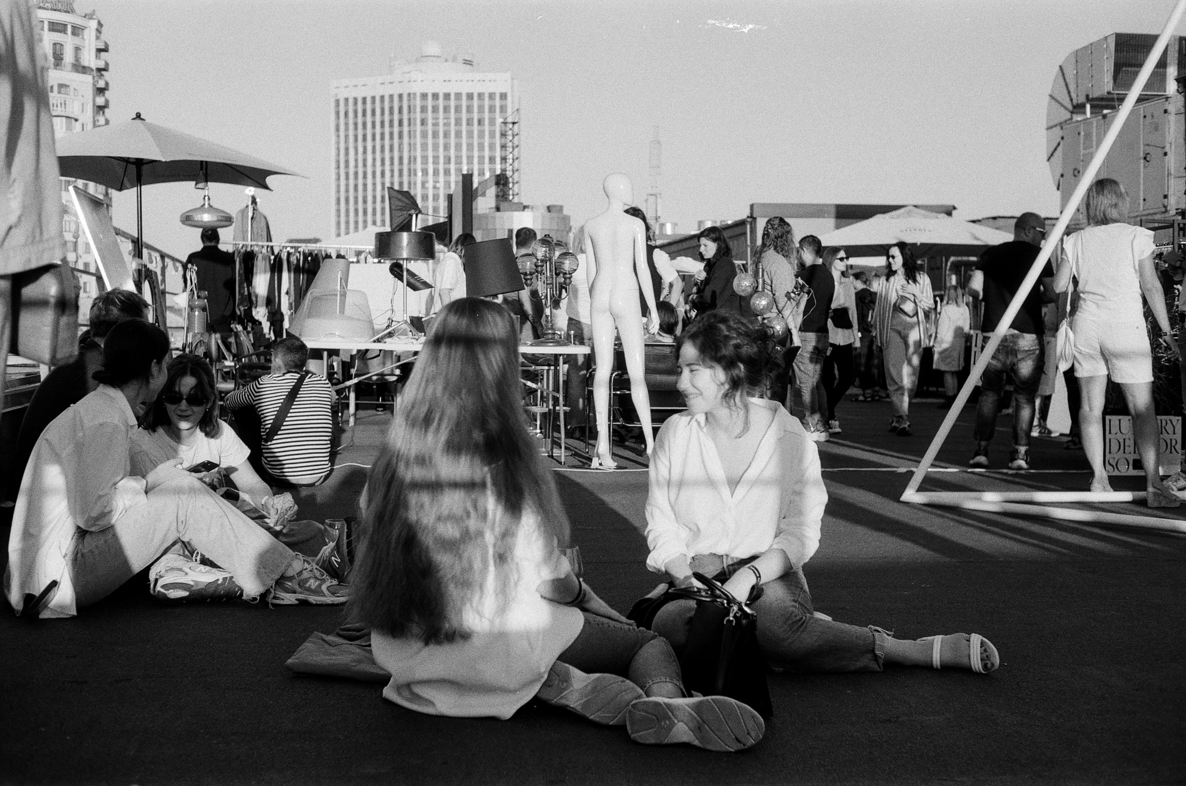 Rooftop Social: Sunlit Gathering Under a Citywide Skyline