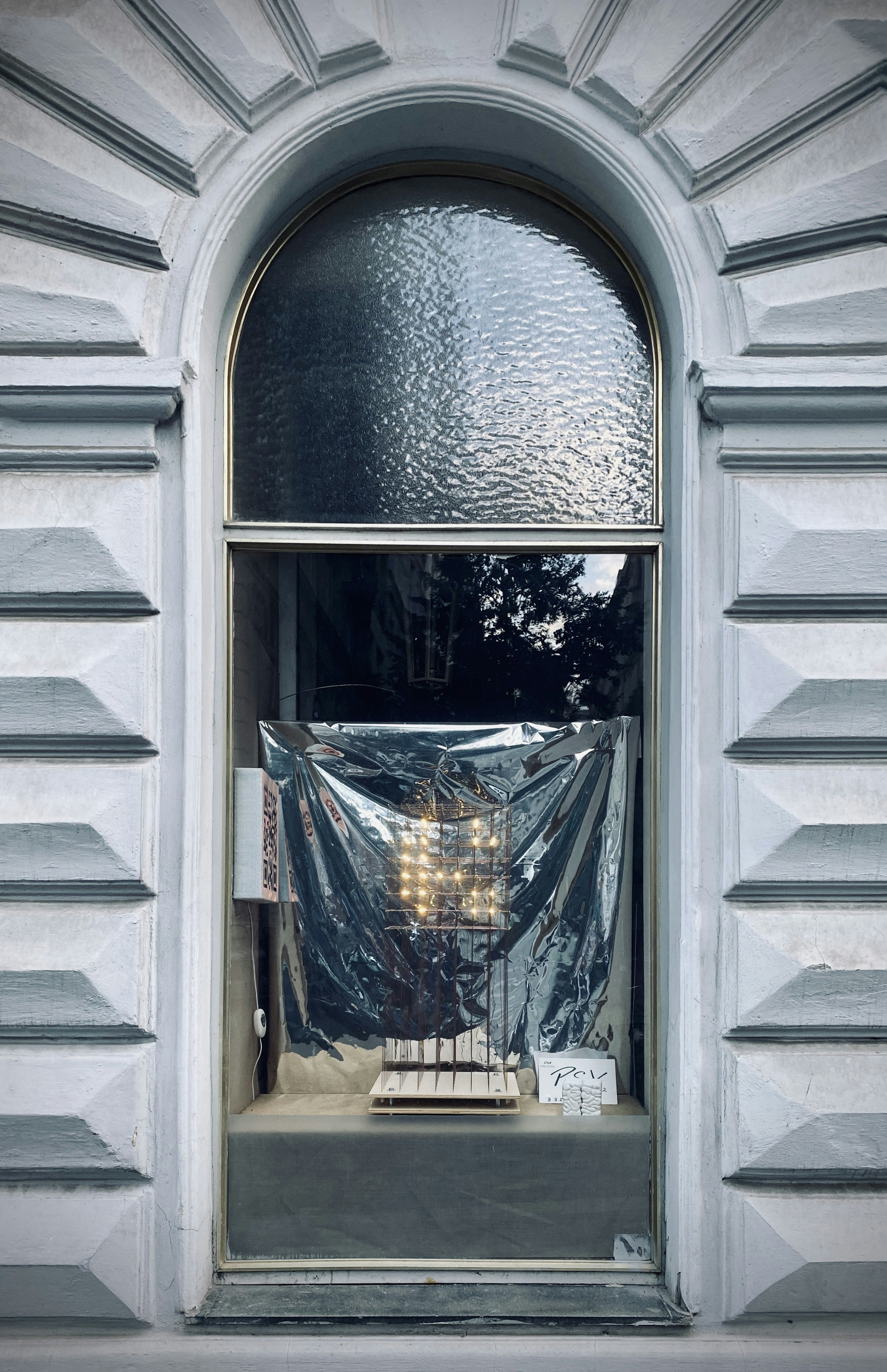 Arched Window Within a Weathered Facade: A Quiet Interior Light