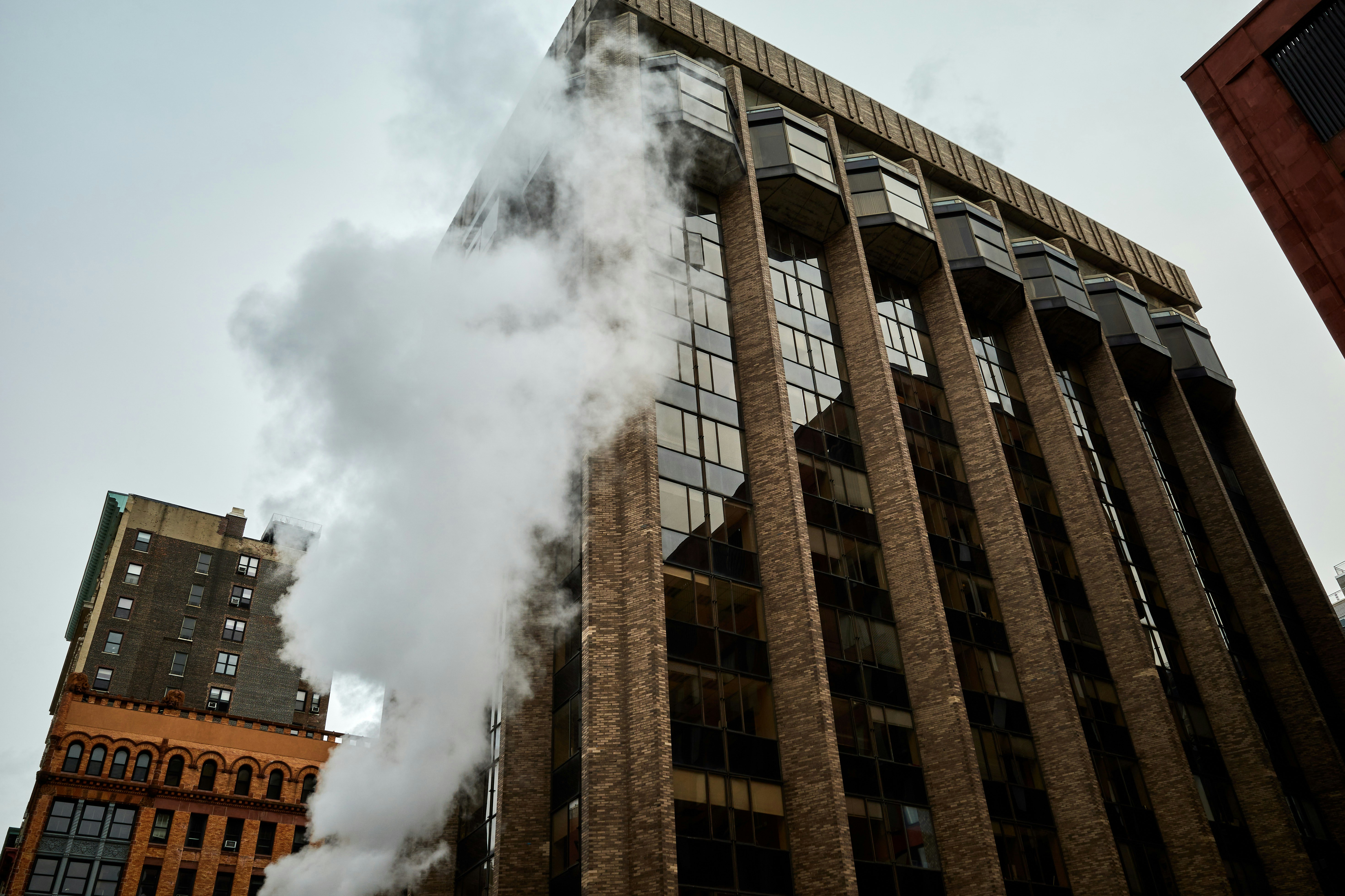 Brown concrete building with smoke photo – Free Building Image on Unsplash