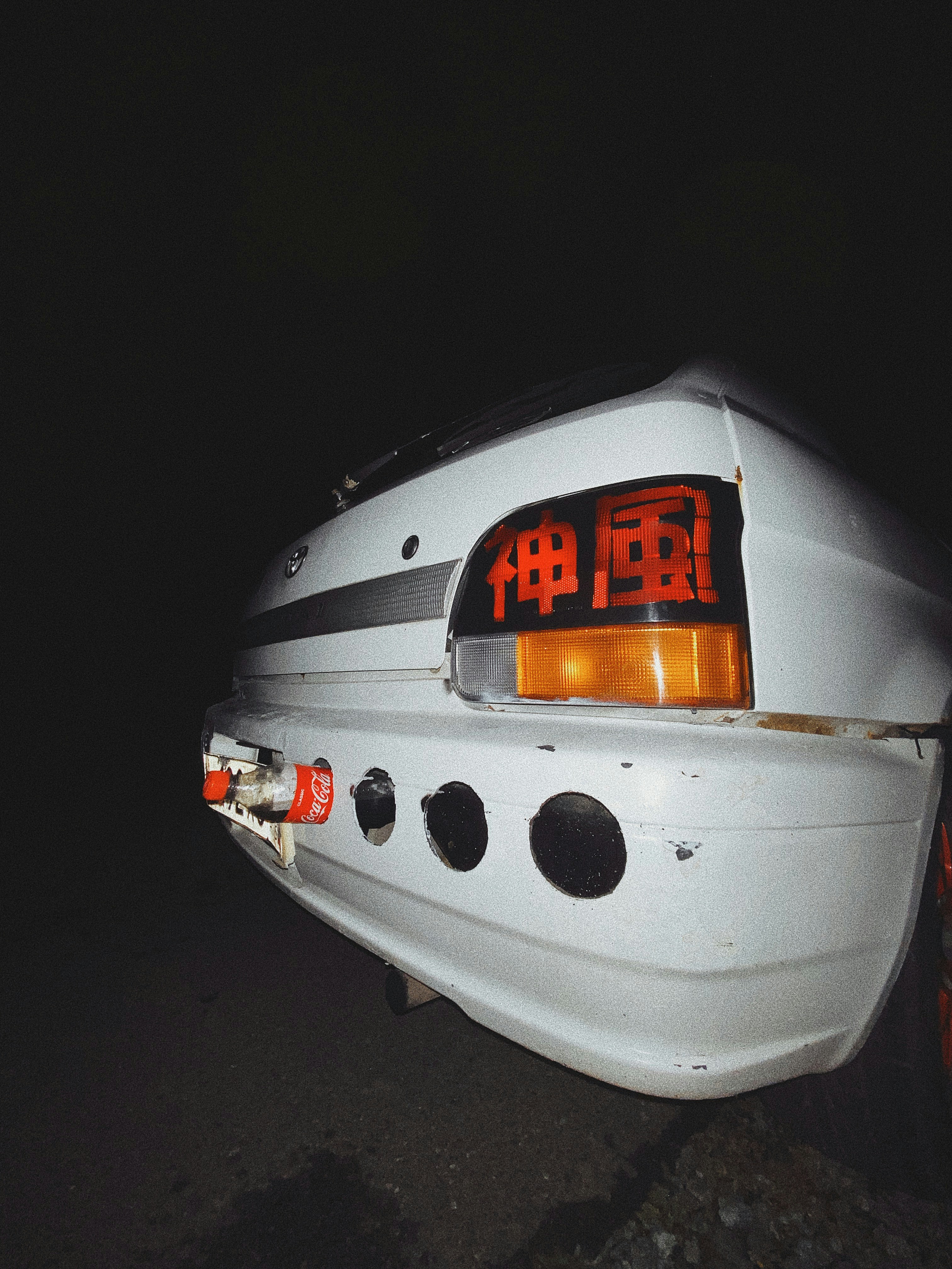 Red Signage in the Night: A Weathered Railcar at the Edge of Light
