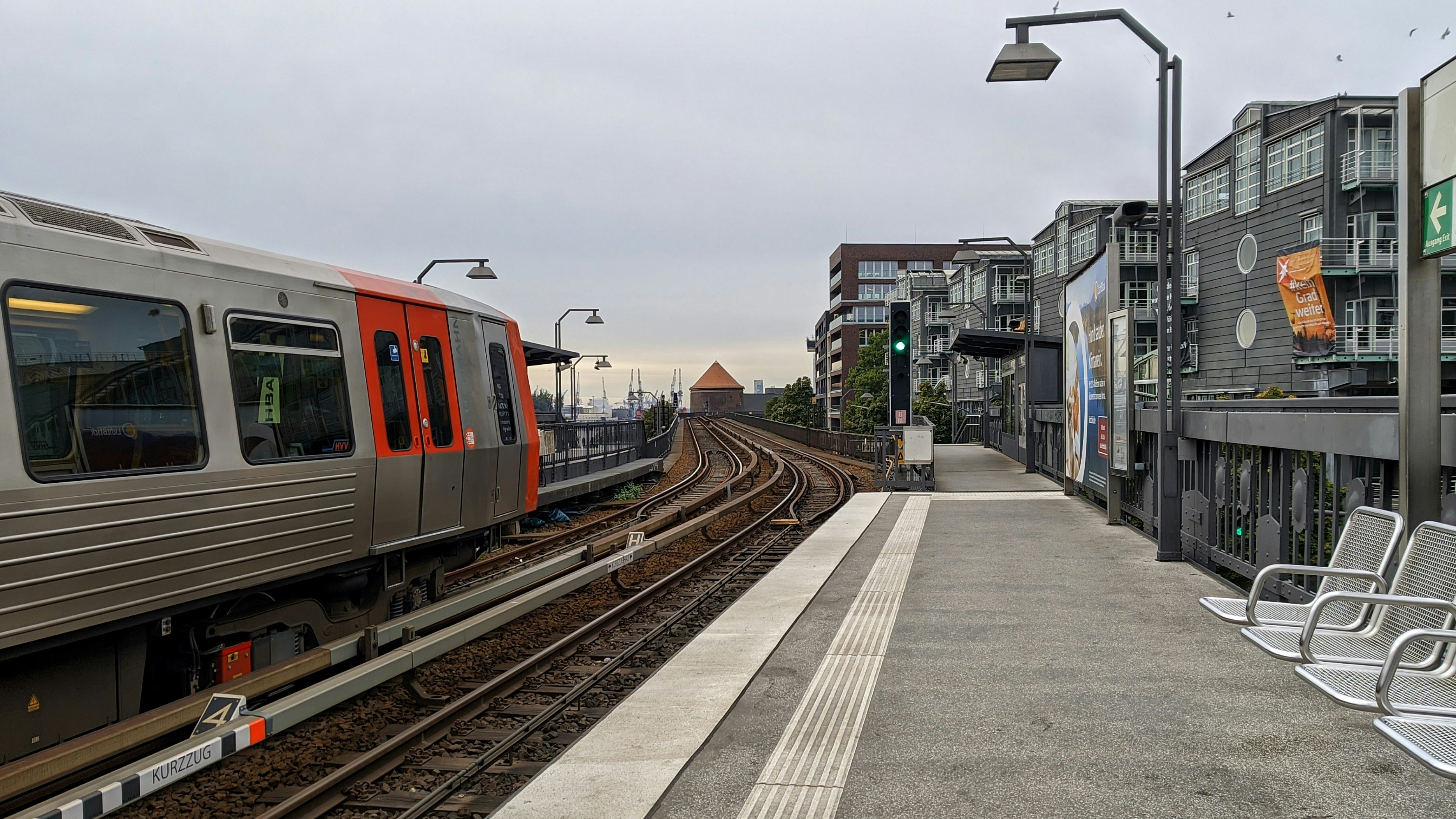 red and white train on rail road during daytime