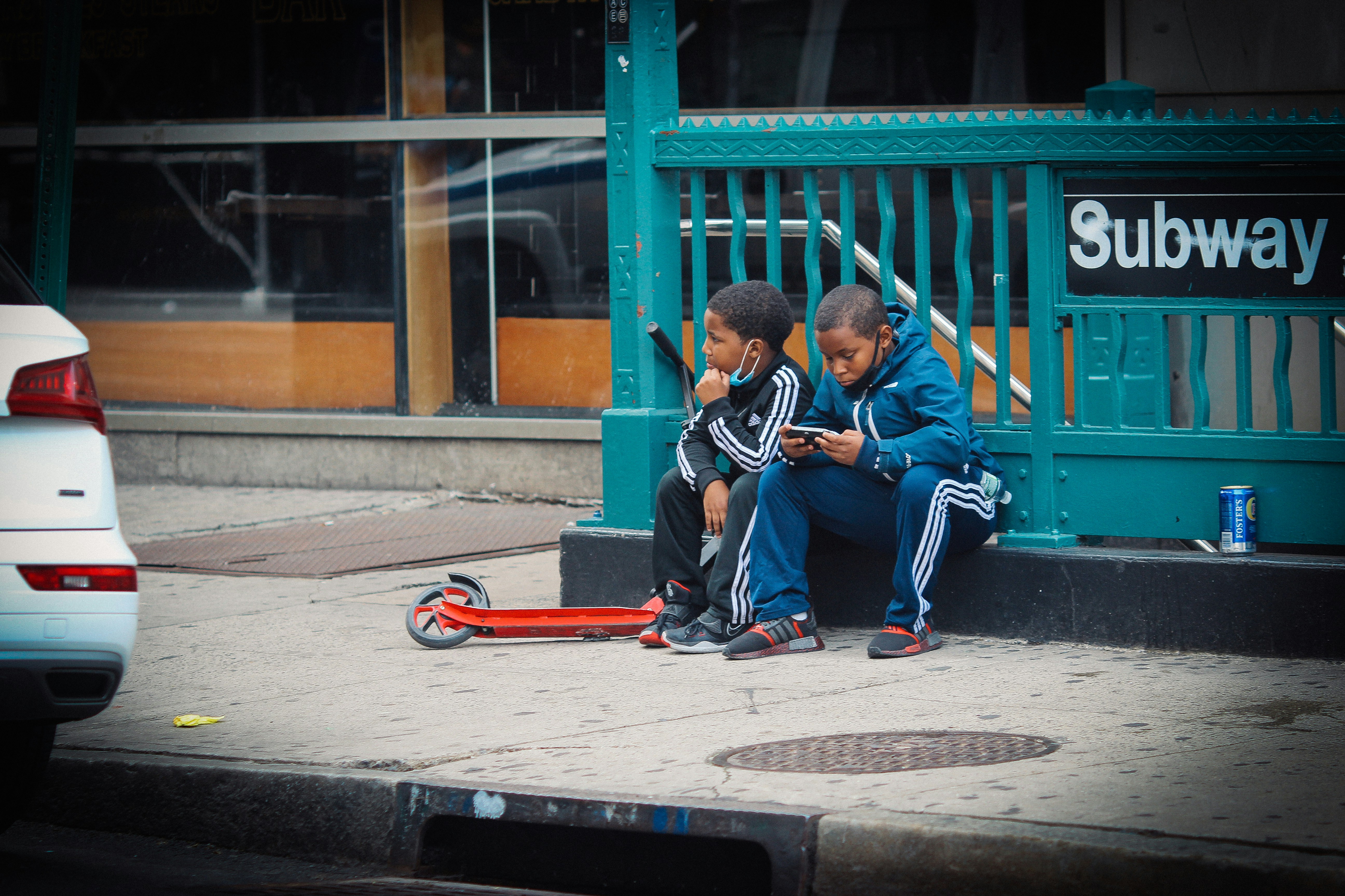 Two Friends on the Curb—Disconnected in a Subway City Scene