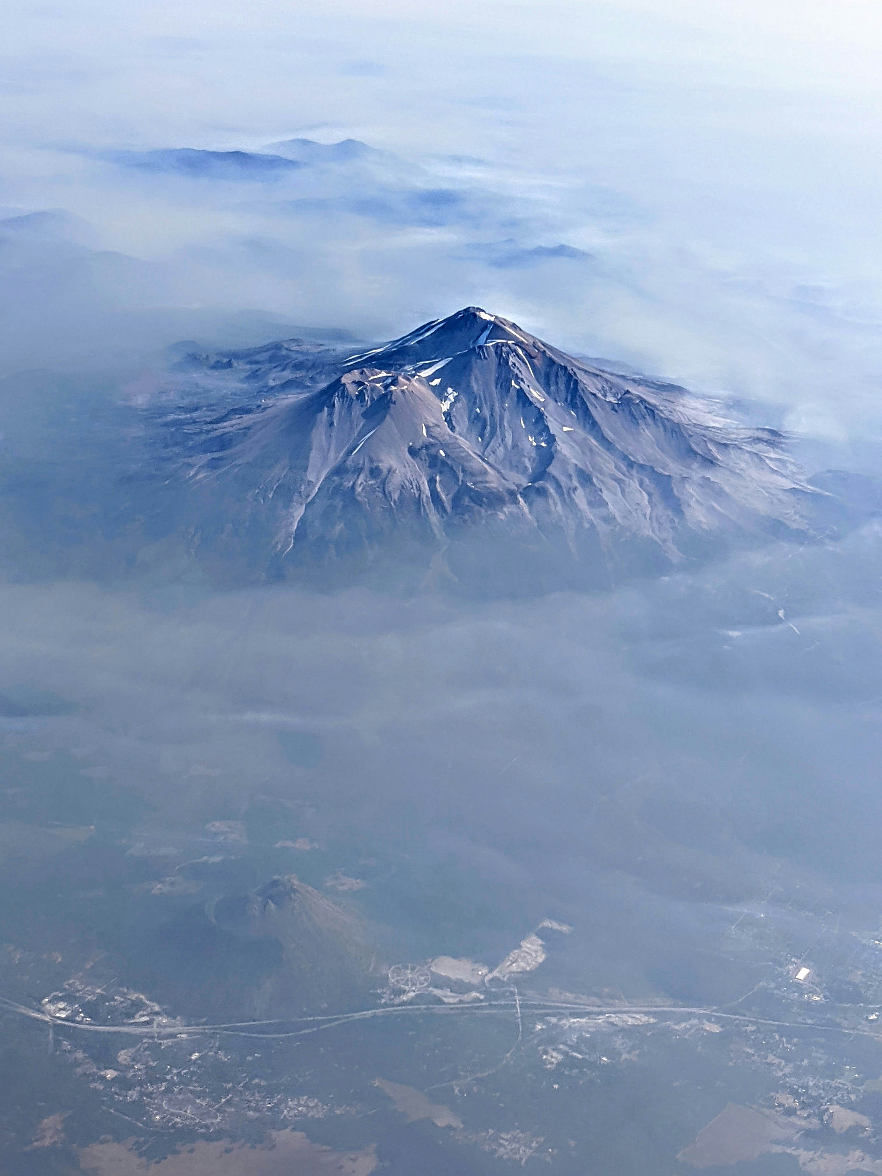 Mist-Wreathed Summit: Snow-Capped Peak Piercing the Clouds
