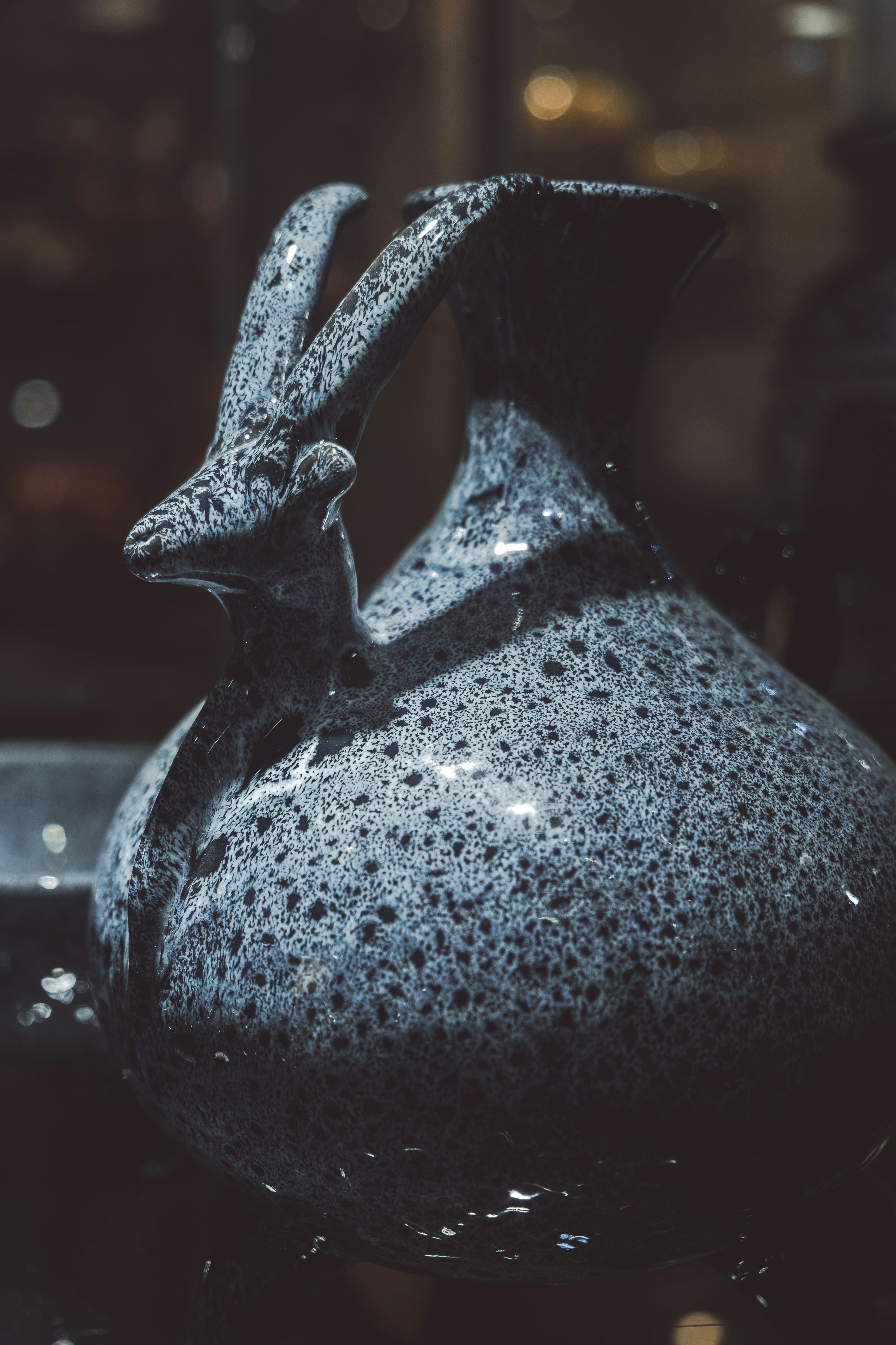 Rain-Dusted Vase: a speckled ceramic silhouette under quiet urban light