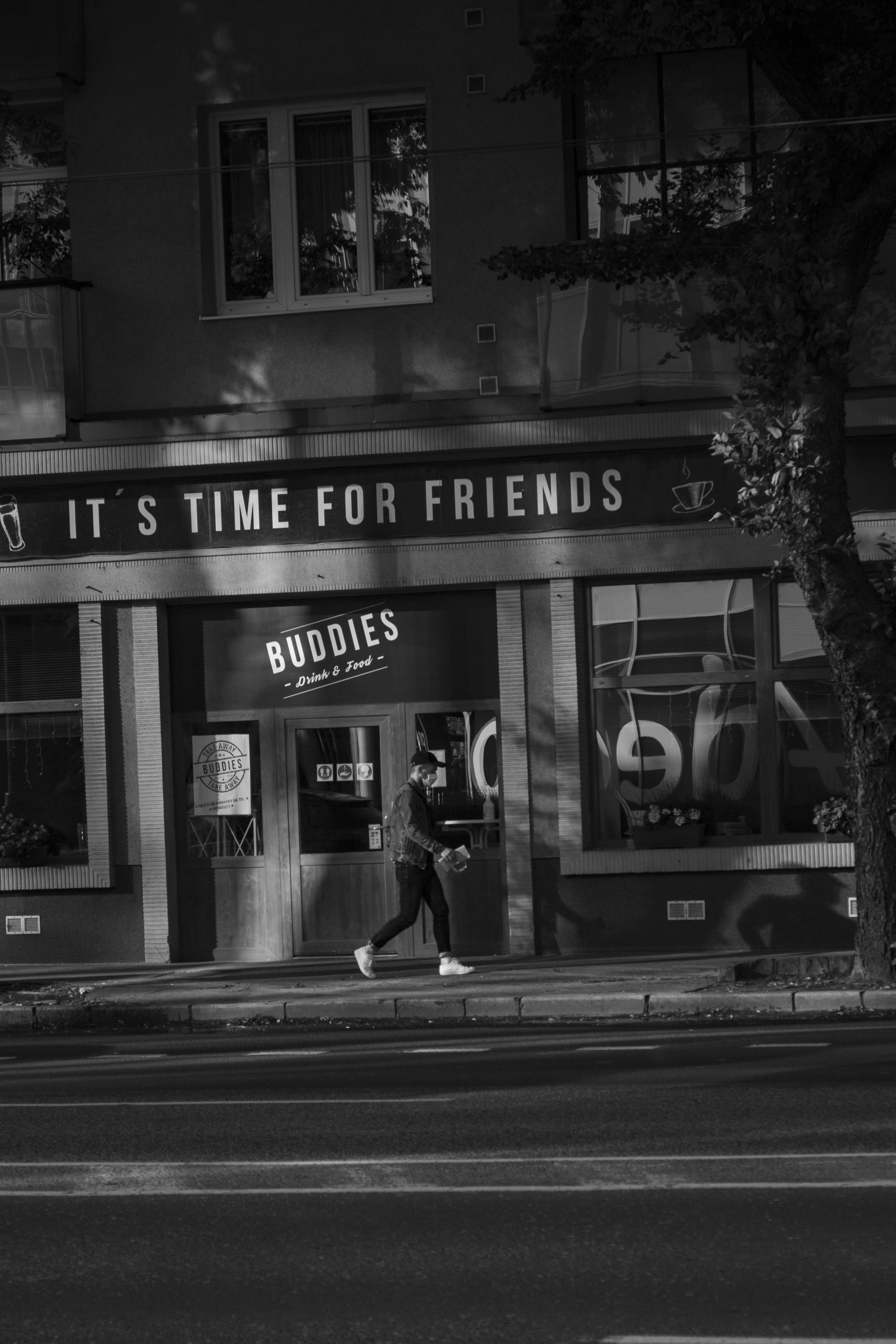 Evening Stroll Past Buddies: A Quiet Street Moment
