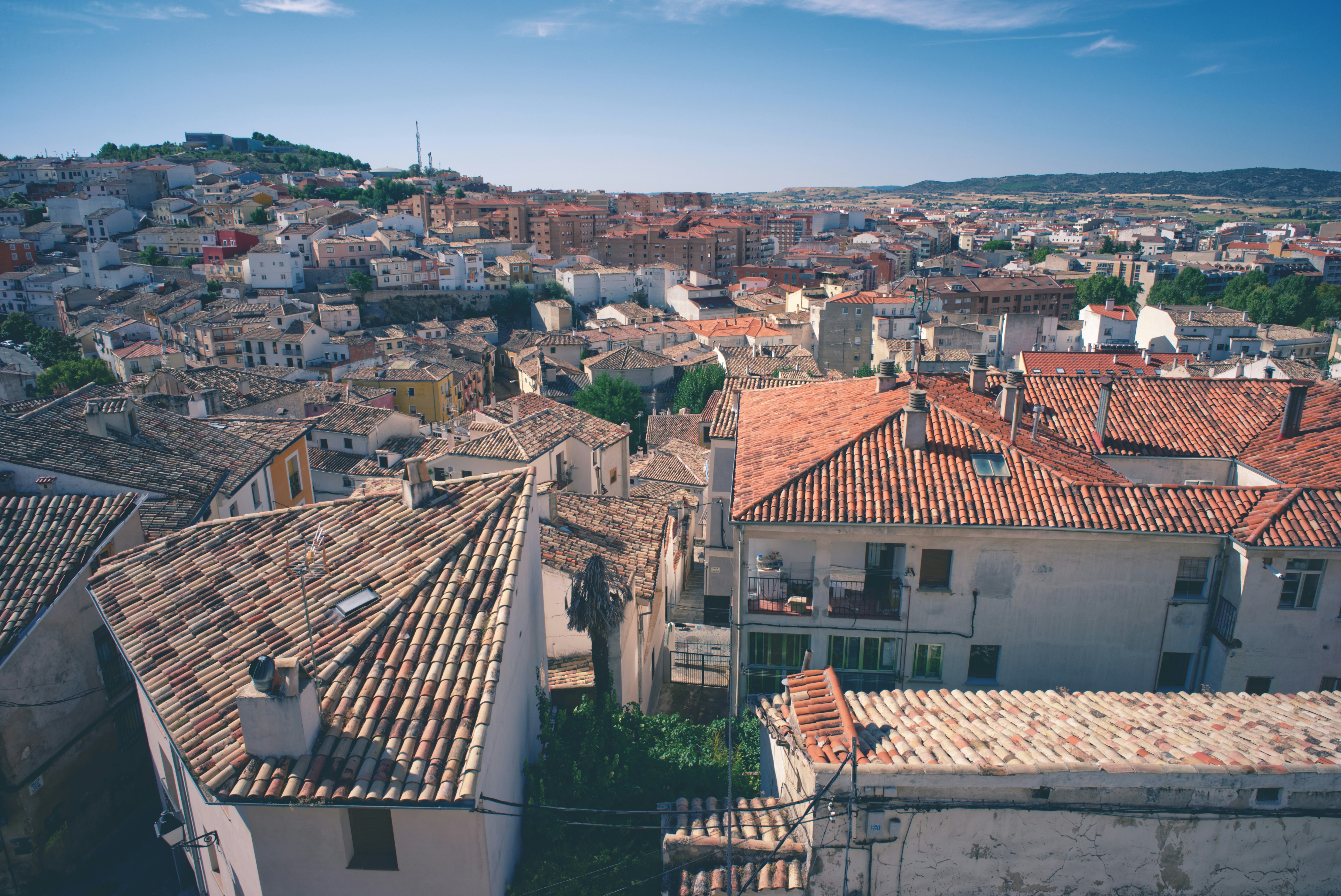 View of Cuenca's terracotta rooftops under a clear blue sky.