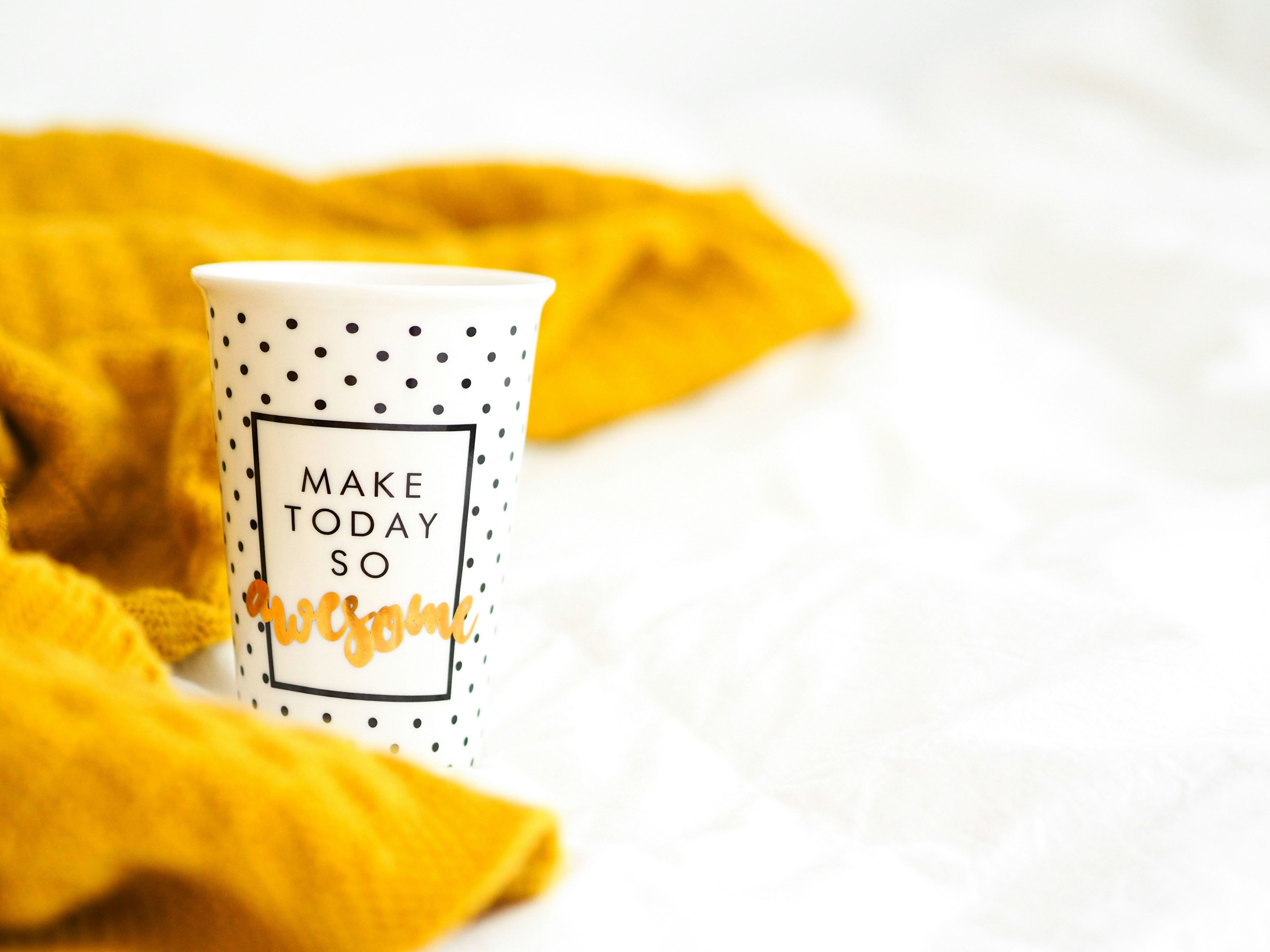 Polka-dotted Cup with Handwritten Accent in a Cozy Setting