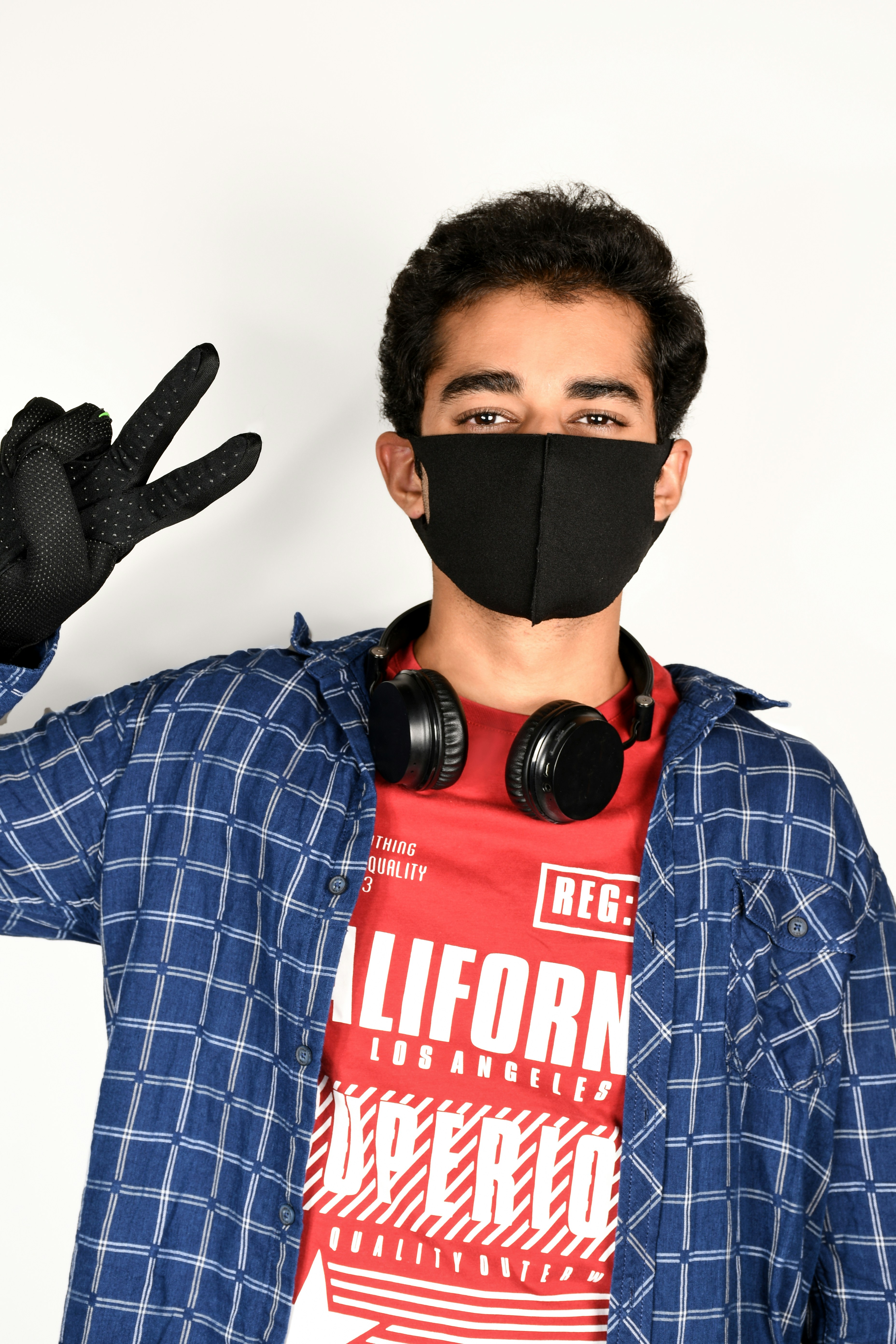 Man in blue and white checkered dress shirt wearing black headphones ...