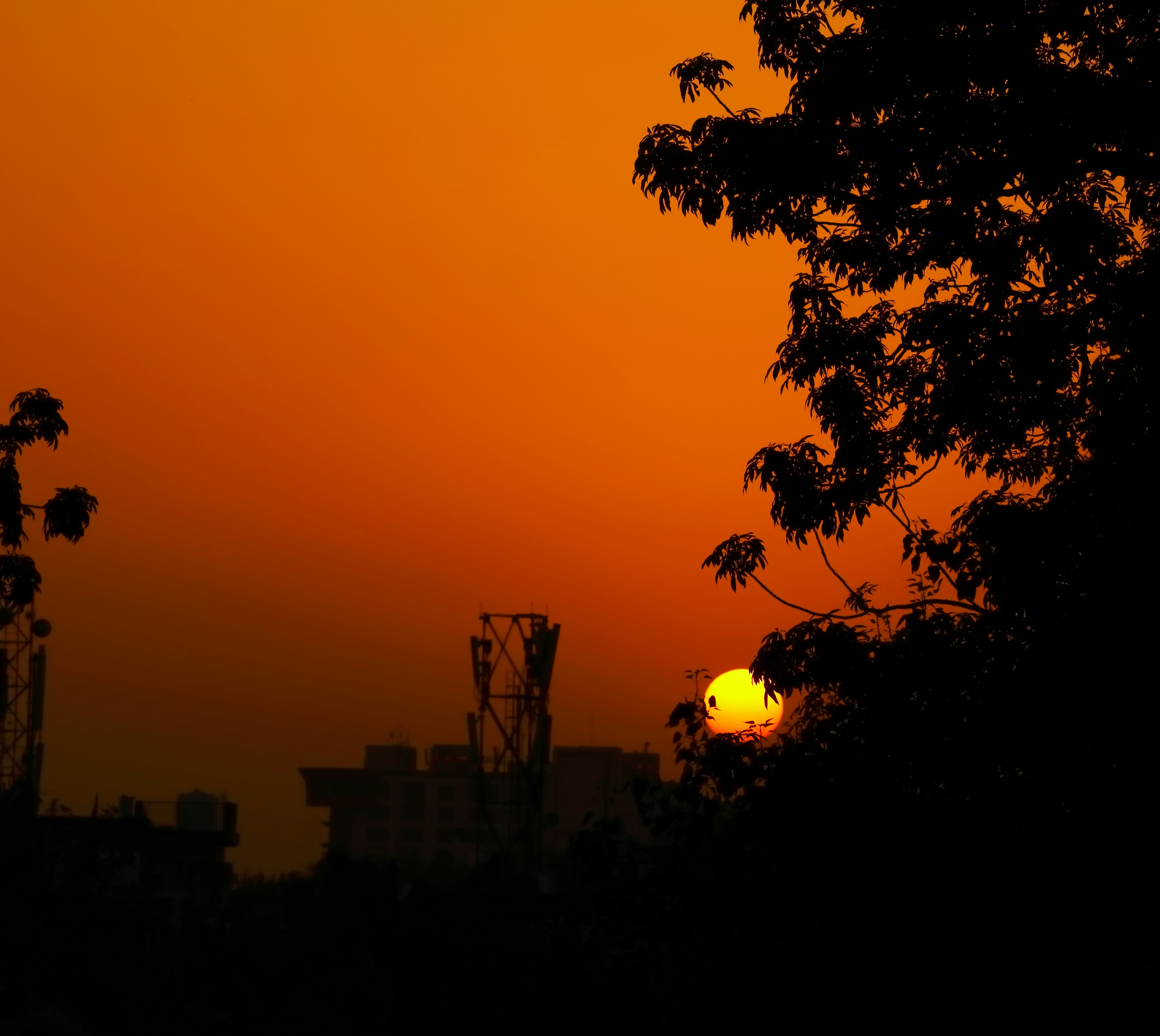 Ember Horizon: Sun Wedges Through Urban Silhouette
