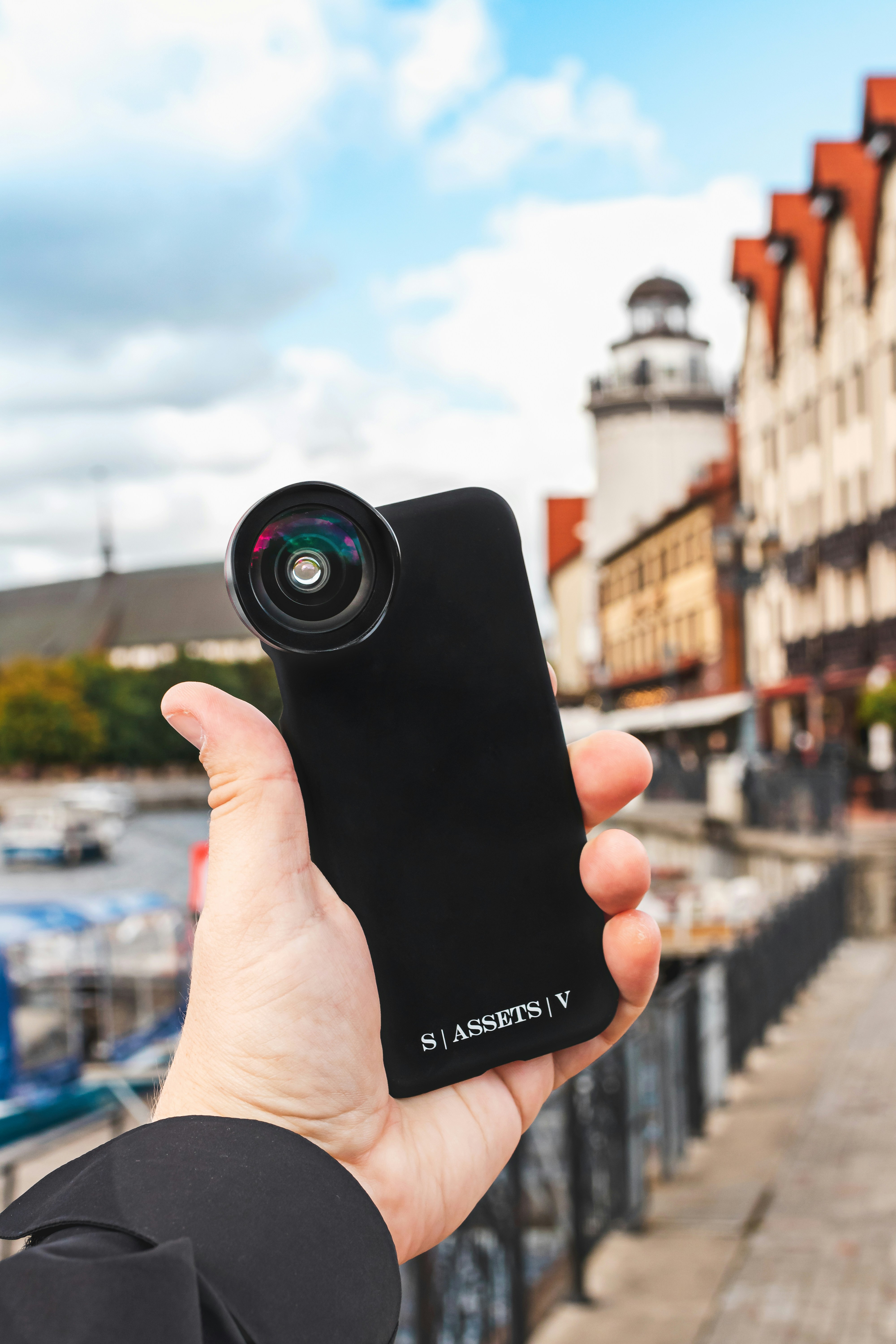 Handheld Lens: A Pocket-Sized Viewfinder Against a European Canal
