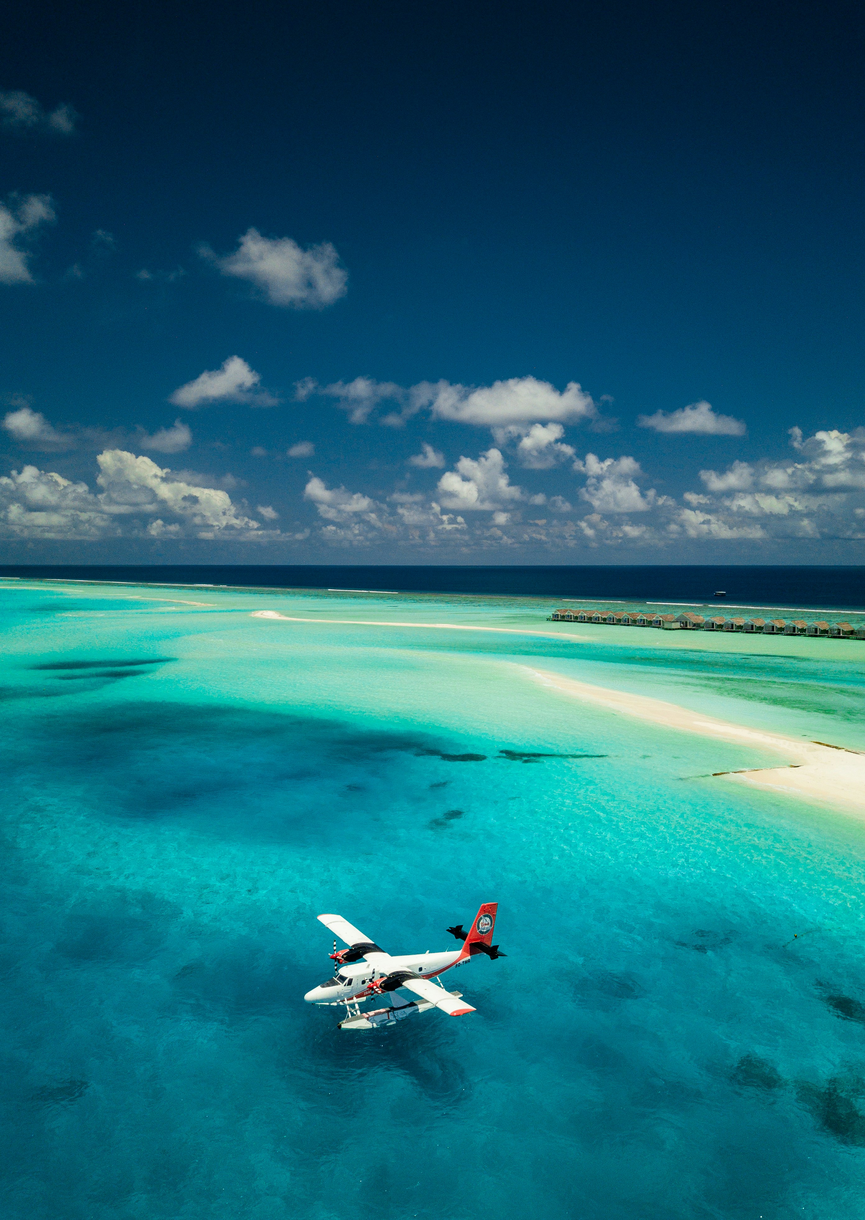 Red-Tailed Seaplane Drifting Over Caribbean Turquoise Lagoon