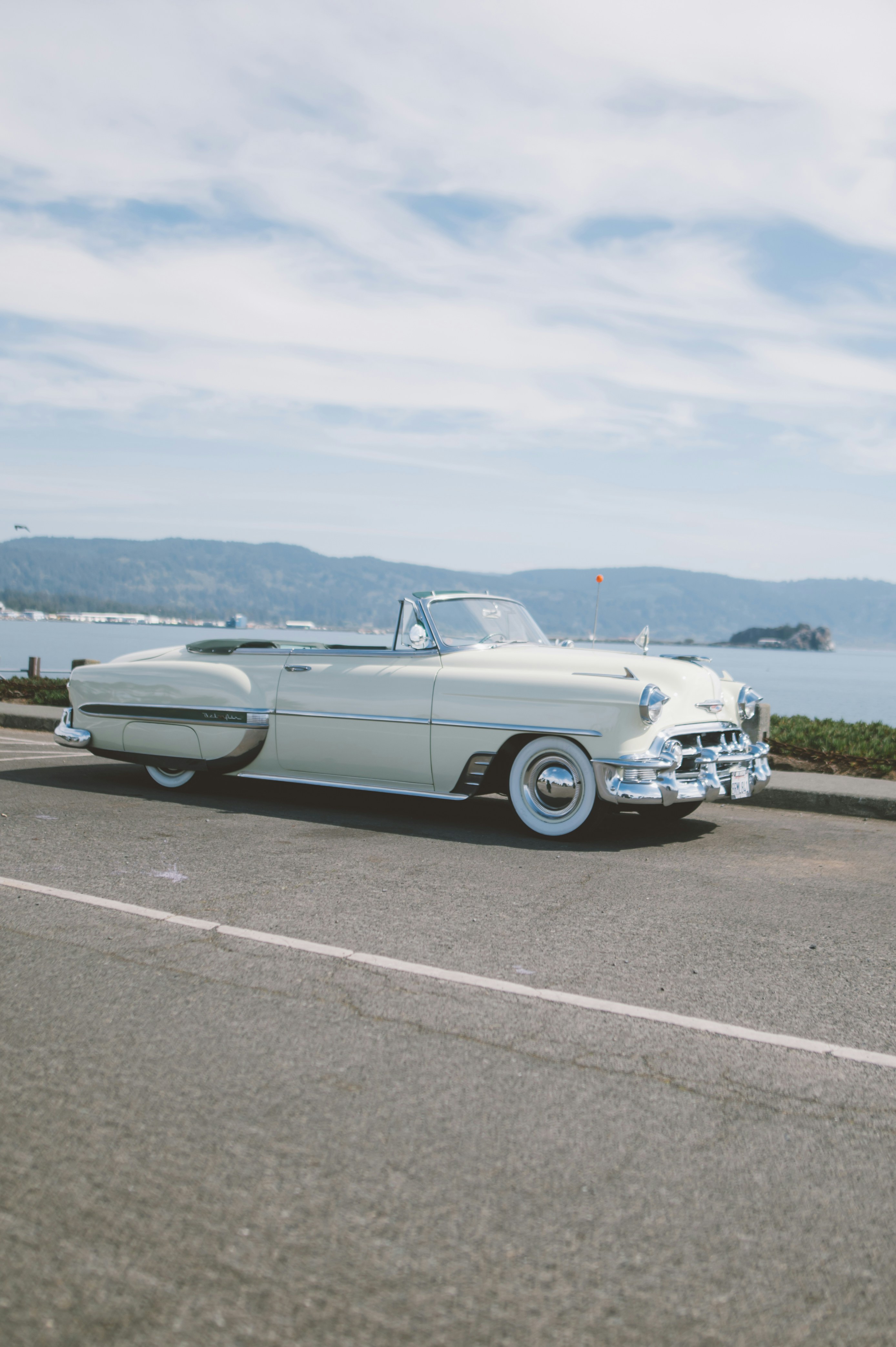 Chrome and Sea: A Mint Convertible Anchored Along a Coastal Promenade