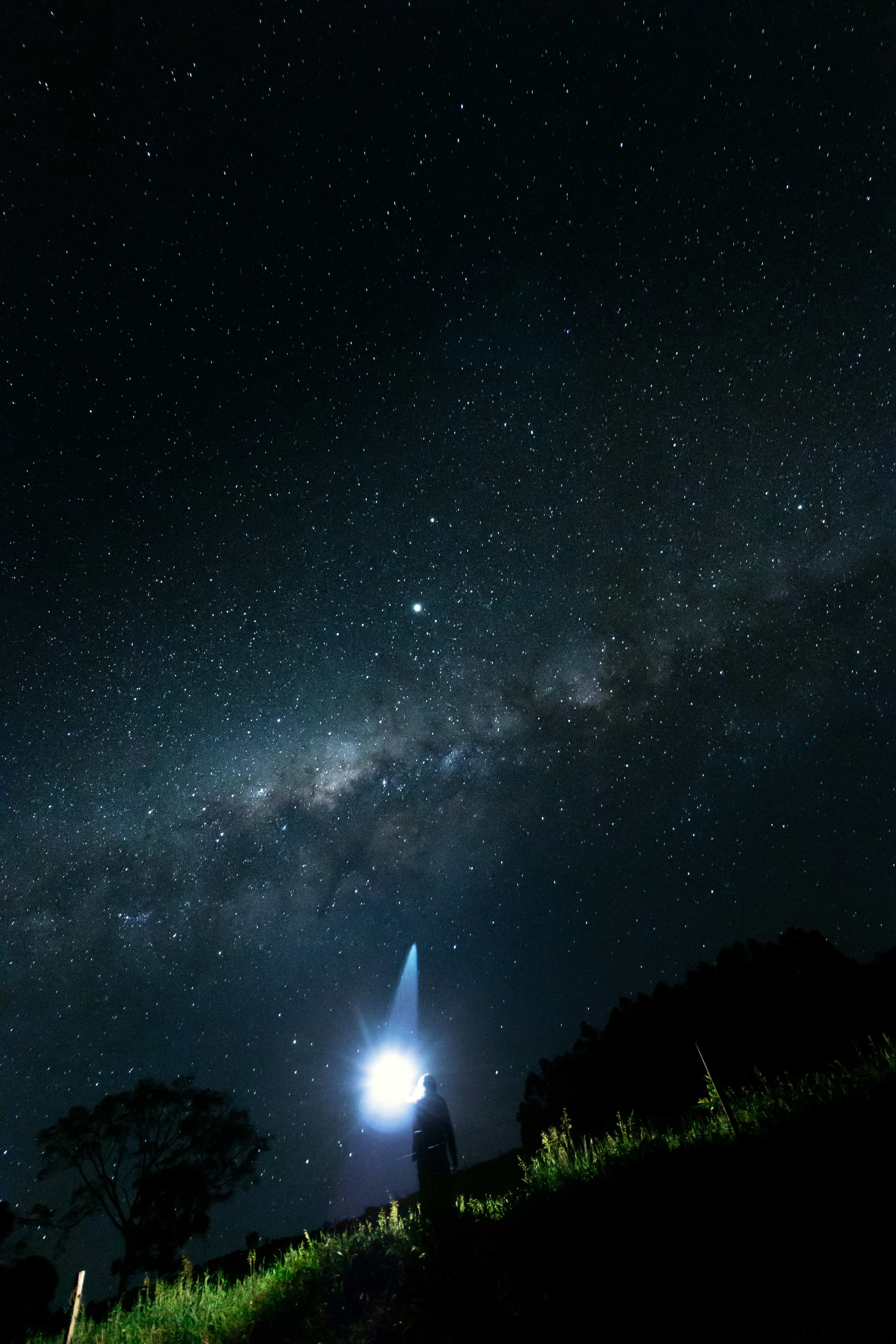 Lone Beacon Beneath a Star-Woven Milky Way