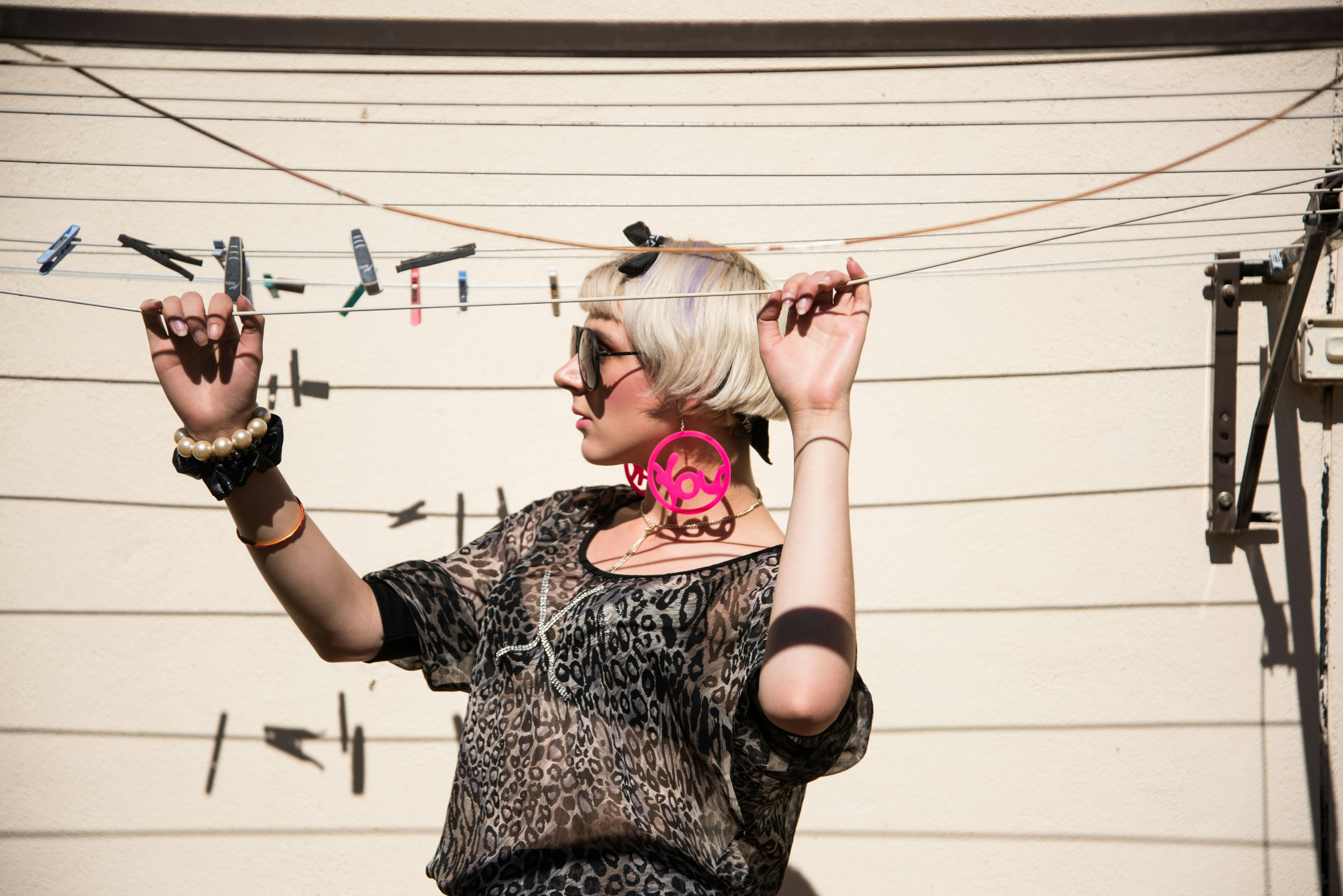 Leaning Against a Sunlit Clothesline: Portrait at Midday