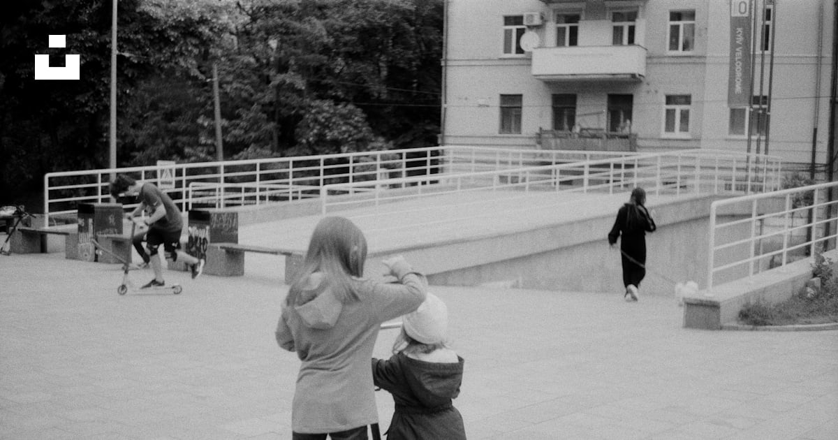 까마귀와 바지를 입은 소녀의 회색조 사진 거리를 걷고 있습니다 사진 Unsplash의 무료 키예프 사이클 트랙 이미지