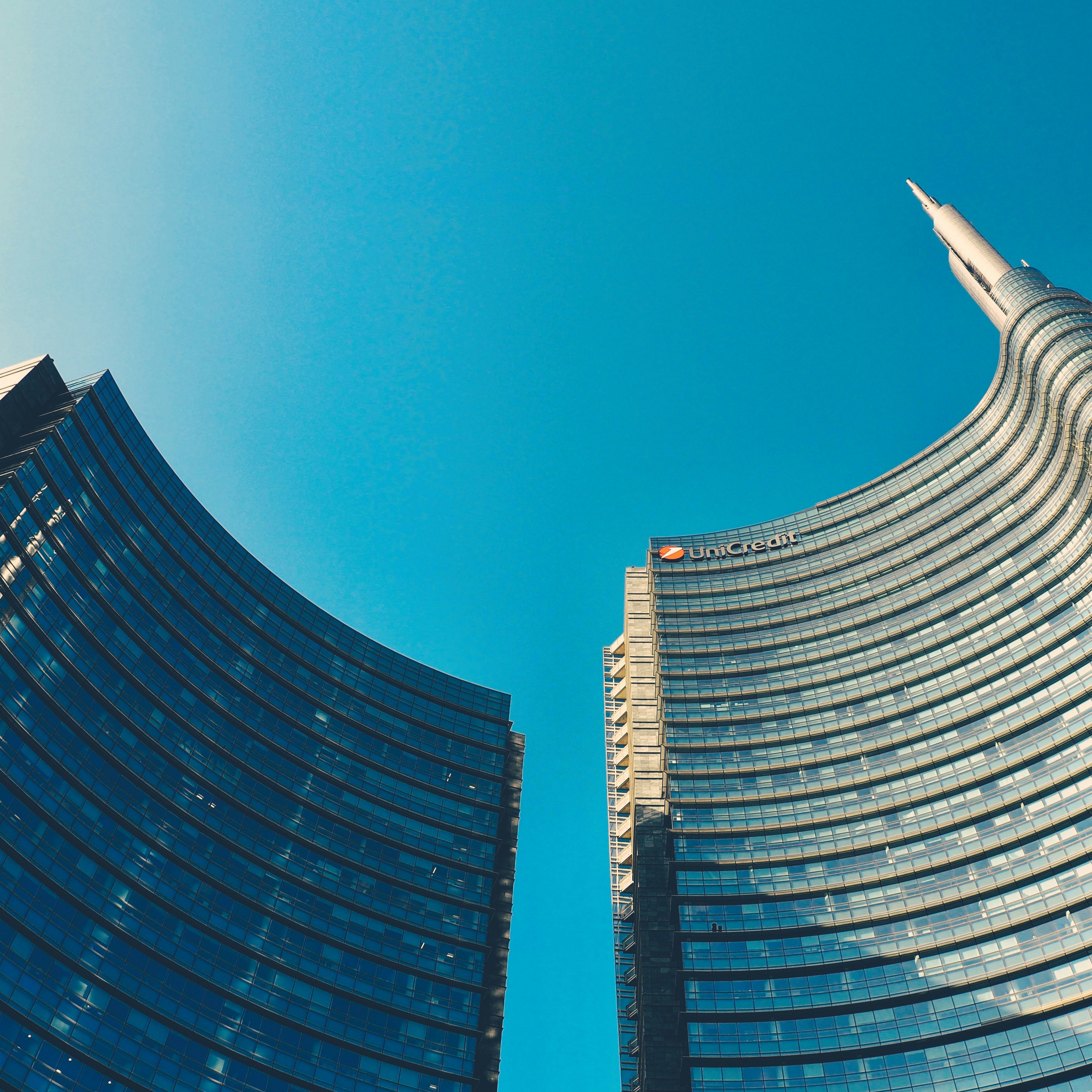 Skyward Crescents: Glass Curves Reaching Toward a Cerulean Sky