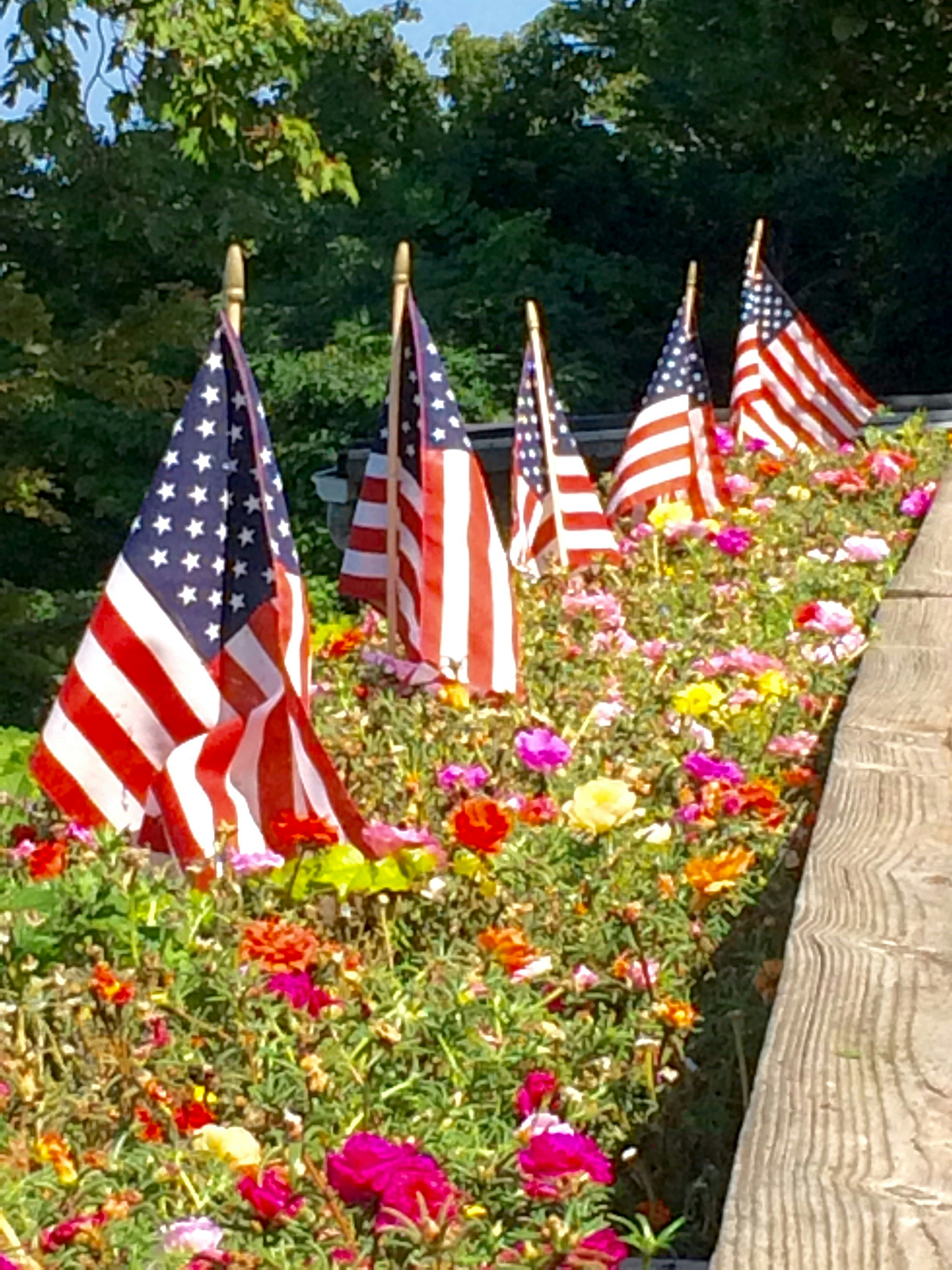 us a flag on brown wooden fence