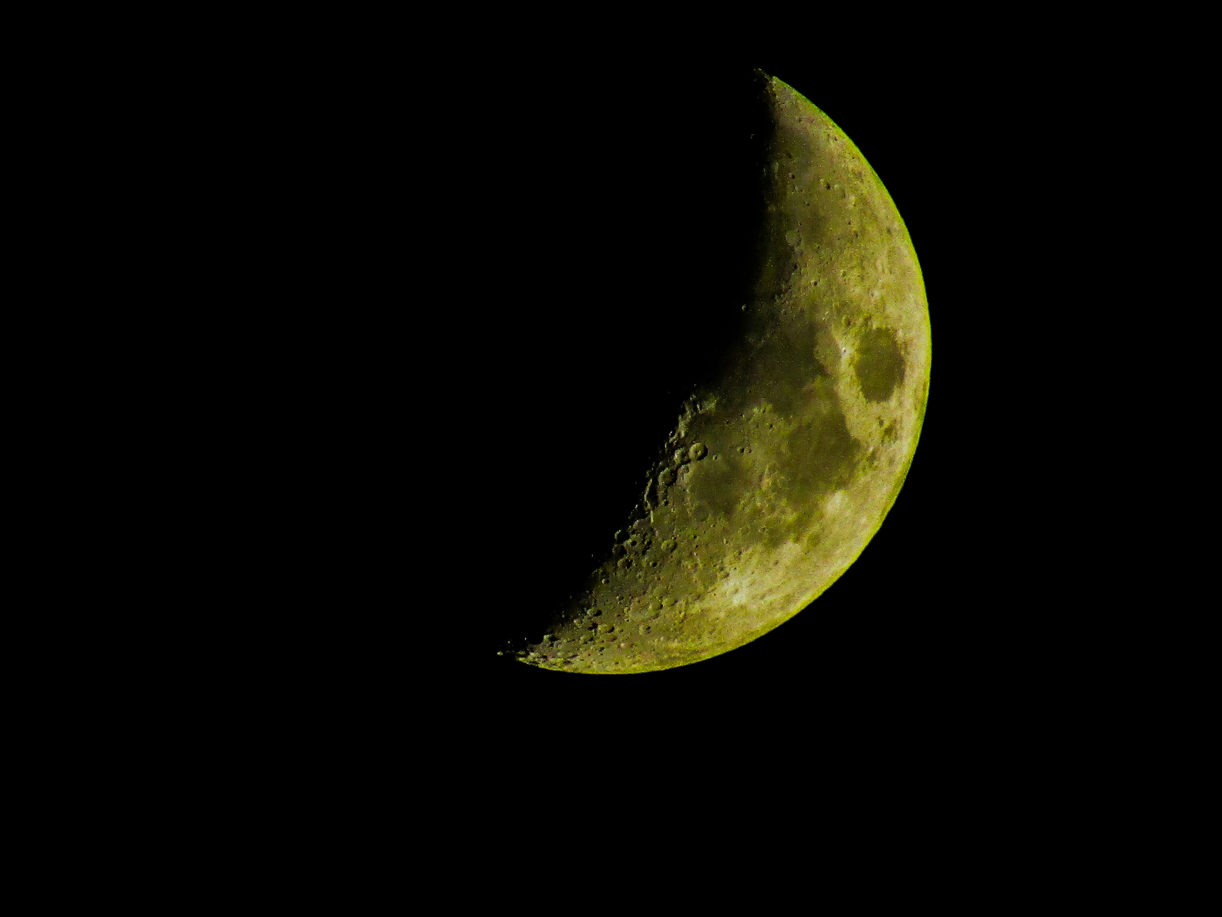 Crescent moon casting a soft glow against a dark night sky.